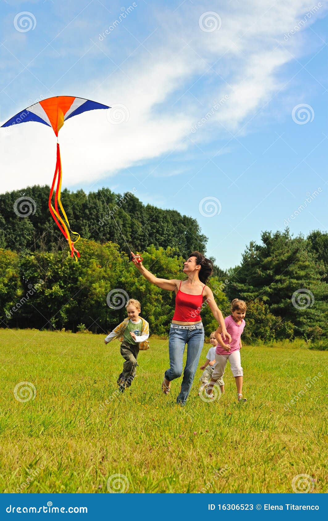 Young Woman And Children Flying A Kite Royalty-Free Stock Photography ...