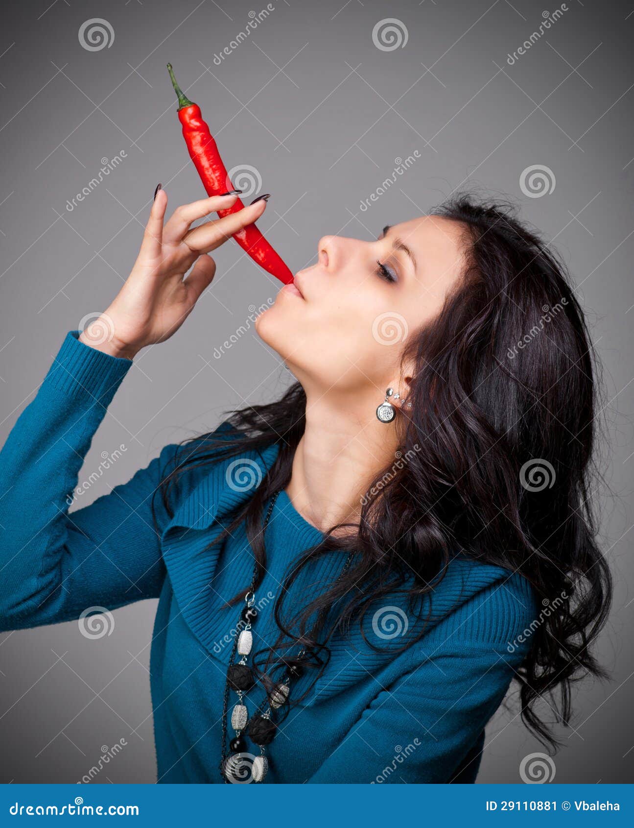 Young Woman with Chili Pepper Stock Image - Image of mouth, spice: 29110881