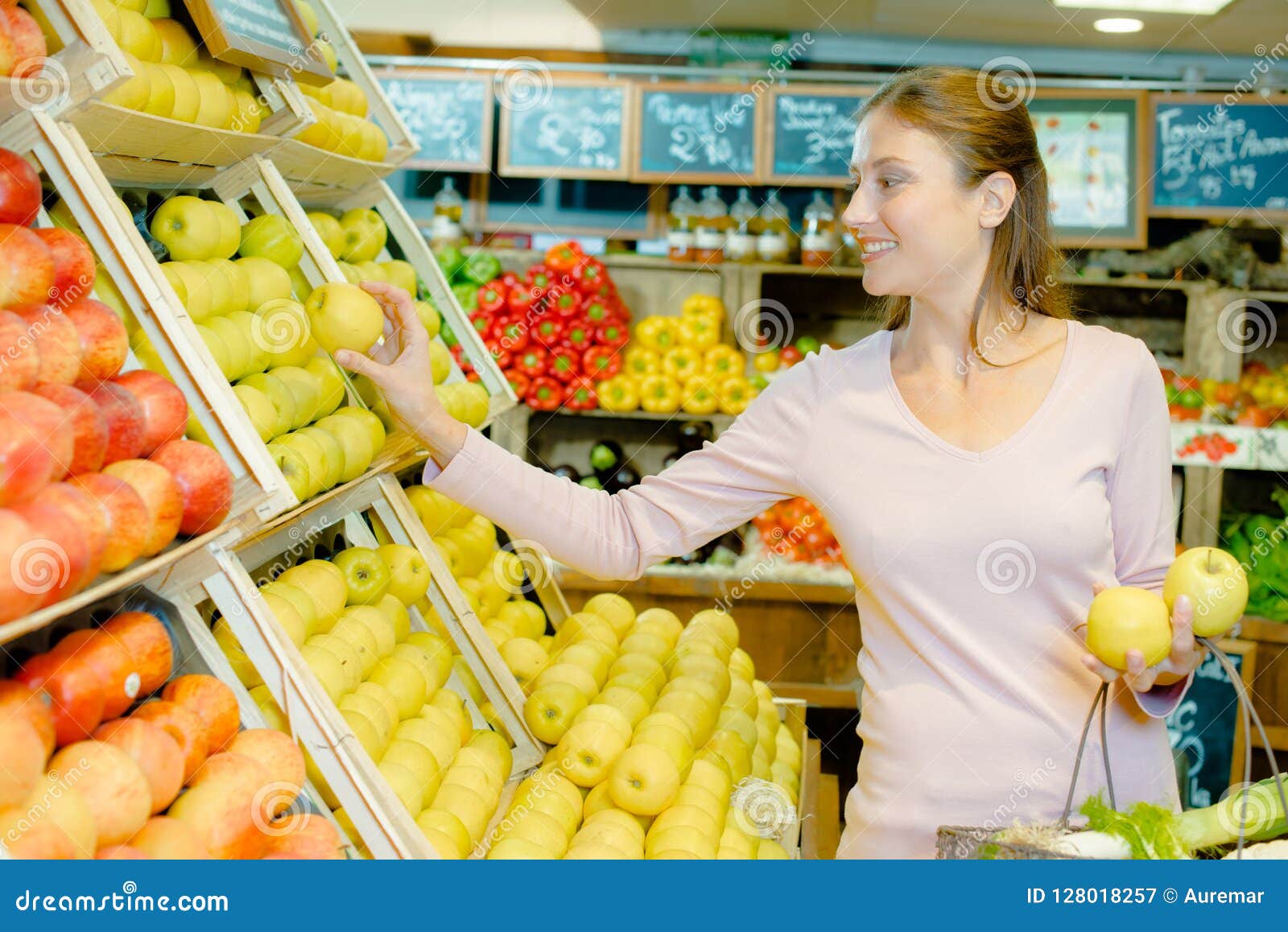 Young Woman Choosing Fruits Stock Image - Image of retailer, holding ...
