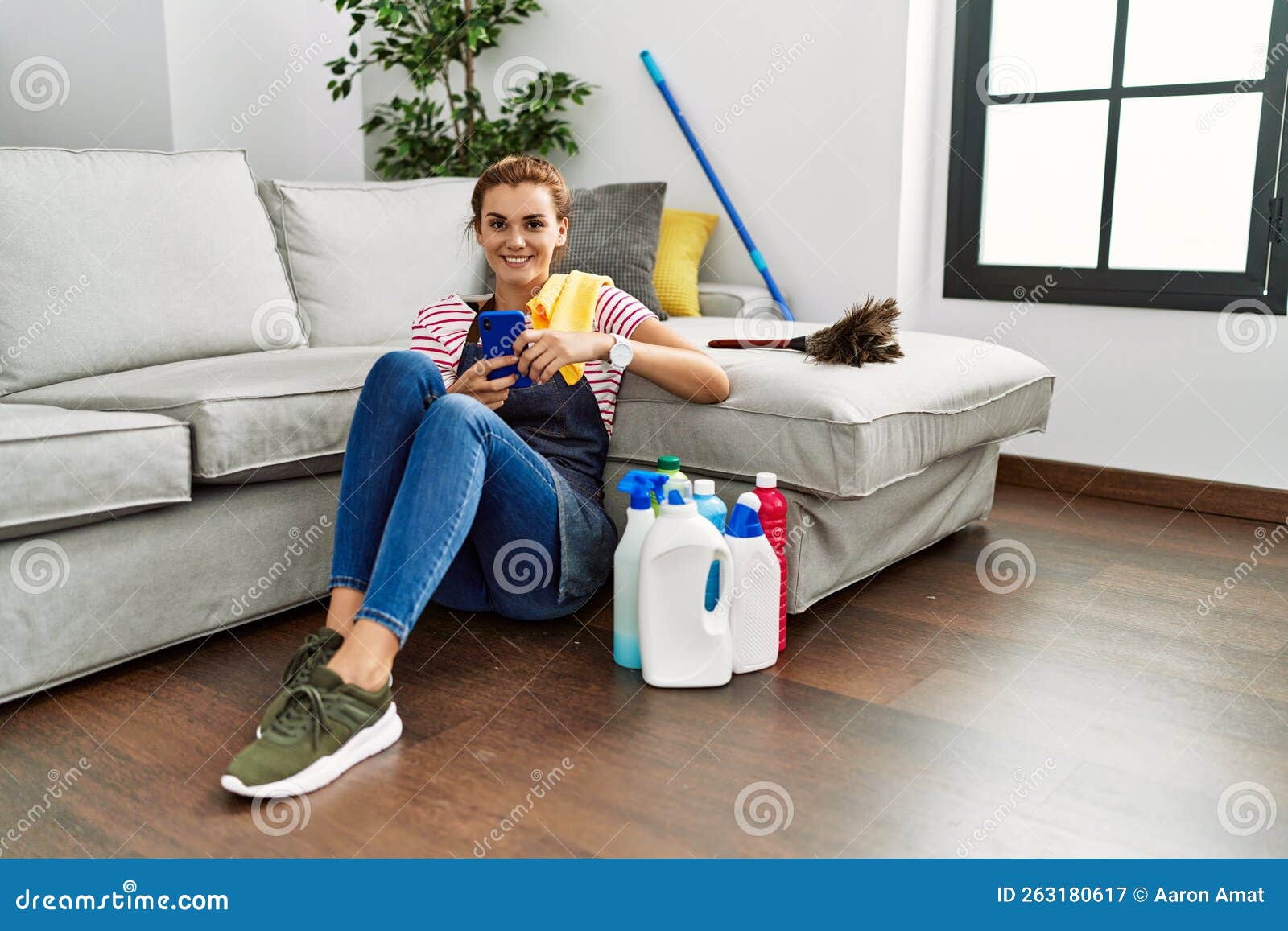 Young Woman Cleaner Using Smartphone Sitting on Floor at Home Stock ...