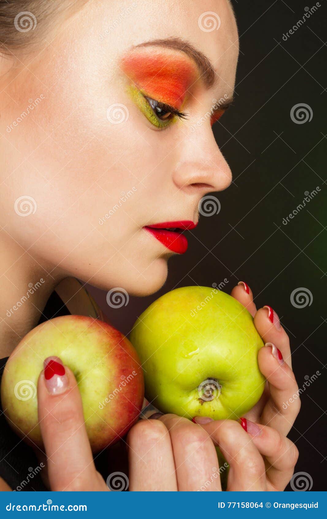 Young Woman with Colored Make-up Holds Apples. Stock Photo - Image of ...