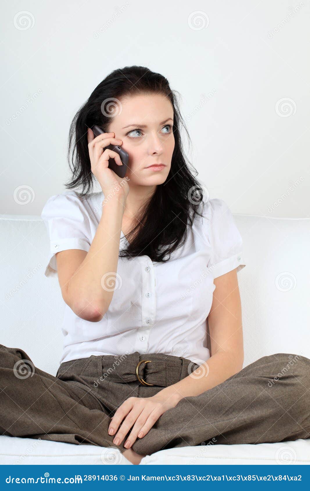 Young Woman Communicates Via Her Cell Phone with Angry Expression Stock ...