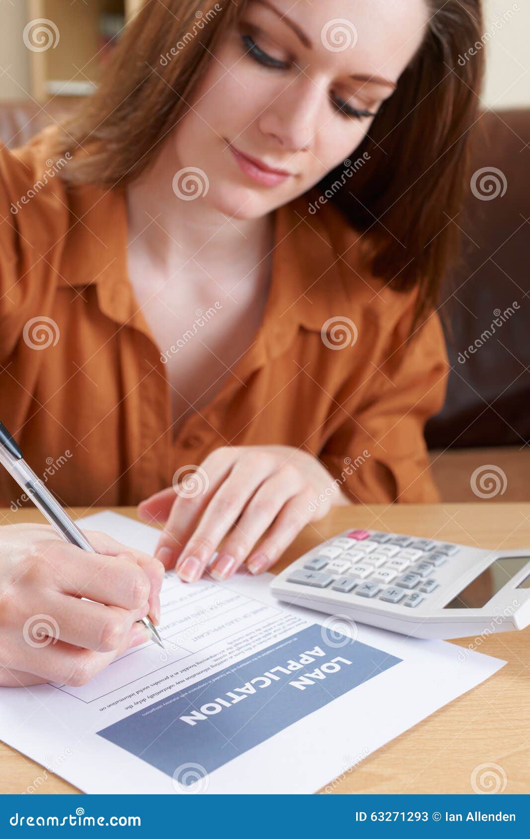 Young Woman Completing Loan Application Form Stock Image - Image of ...