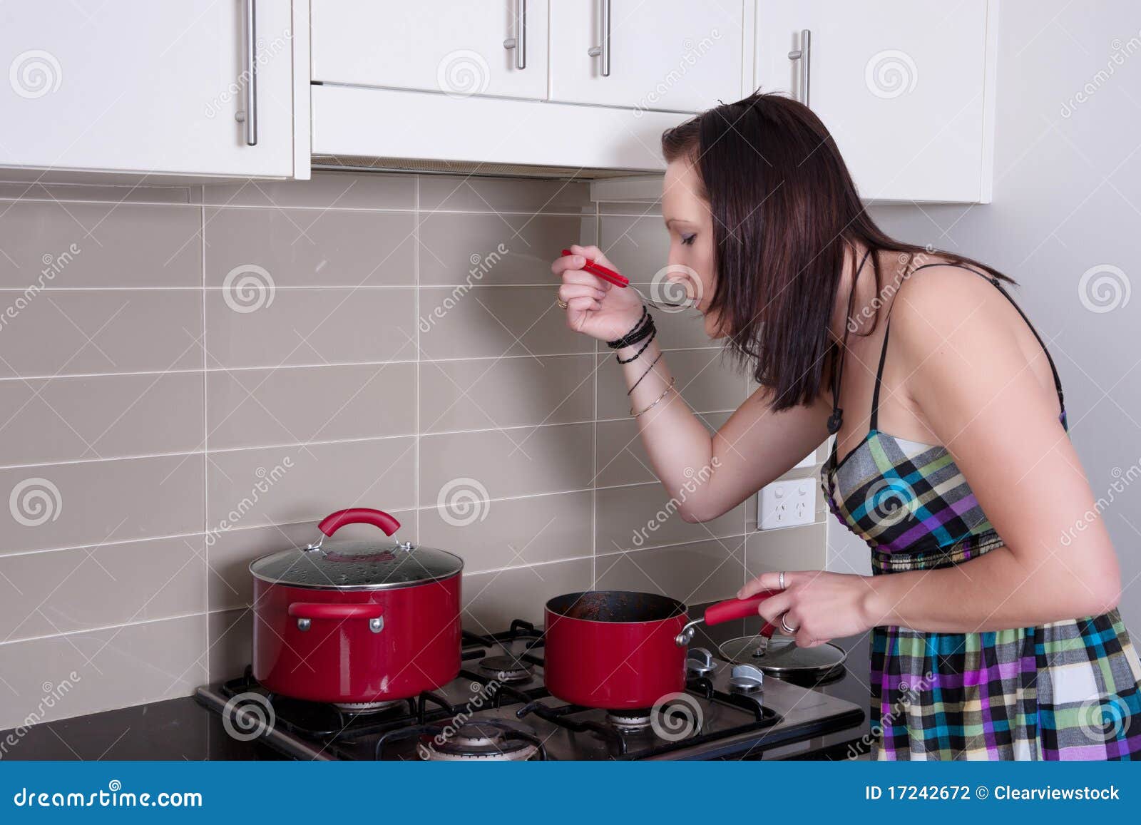 Young woman cooking dinner stock photo. Image of food - 17242672