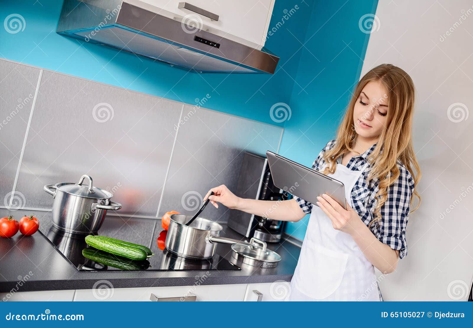 Young woman cooking dinner stock image. Image of modern - 65105027