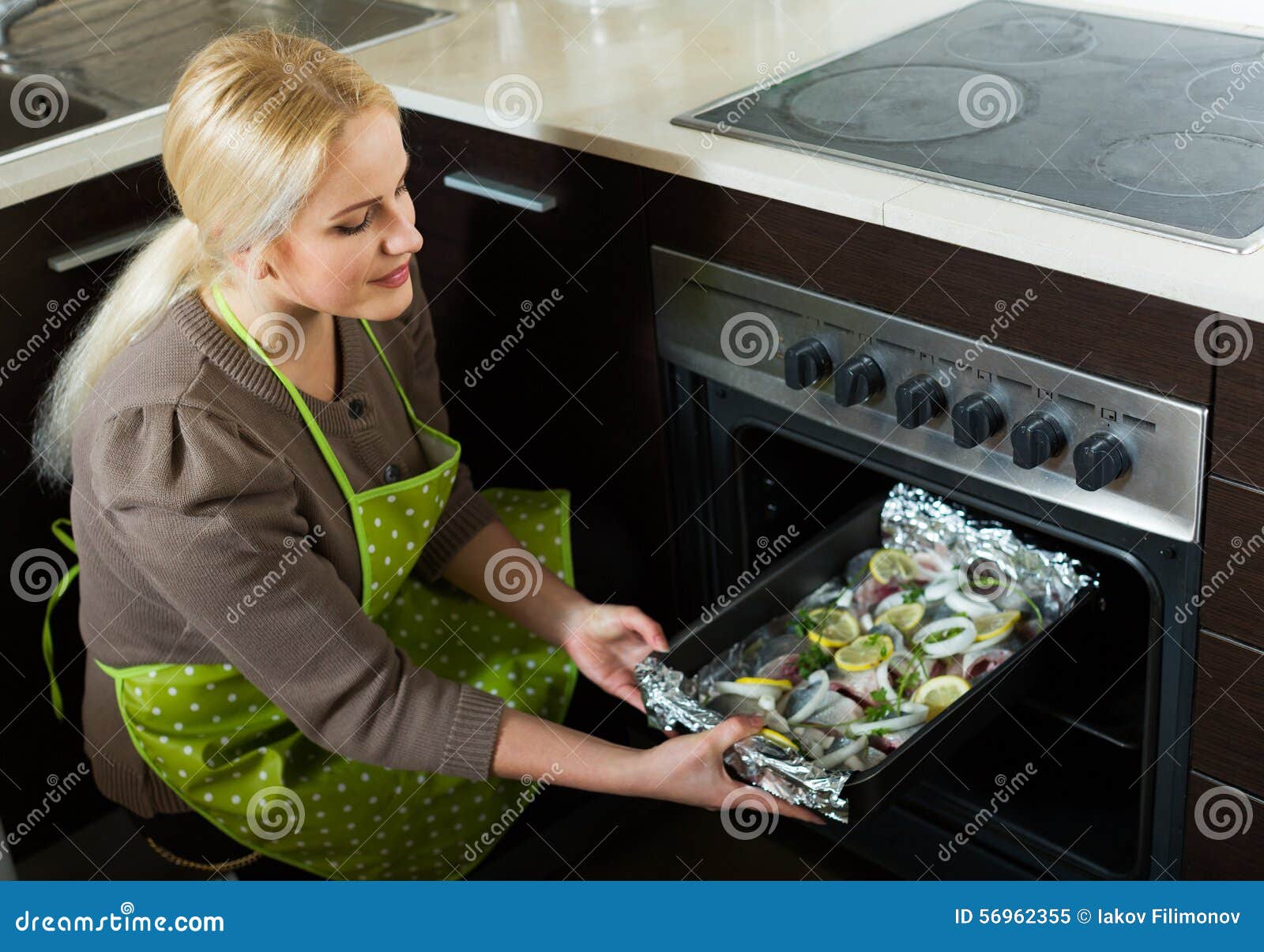 Young woman cooking fish stock image. Image of panful - 56962355