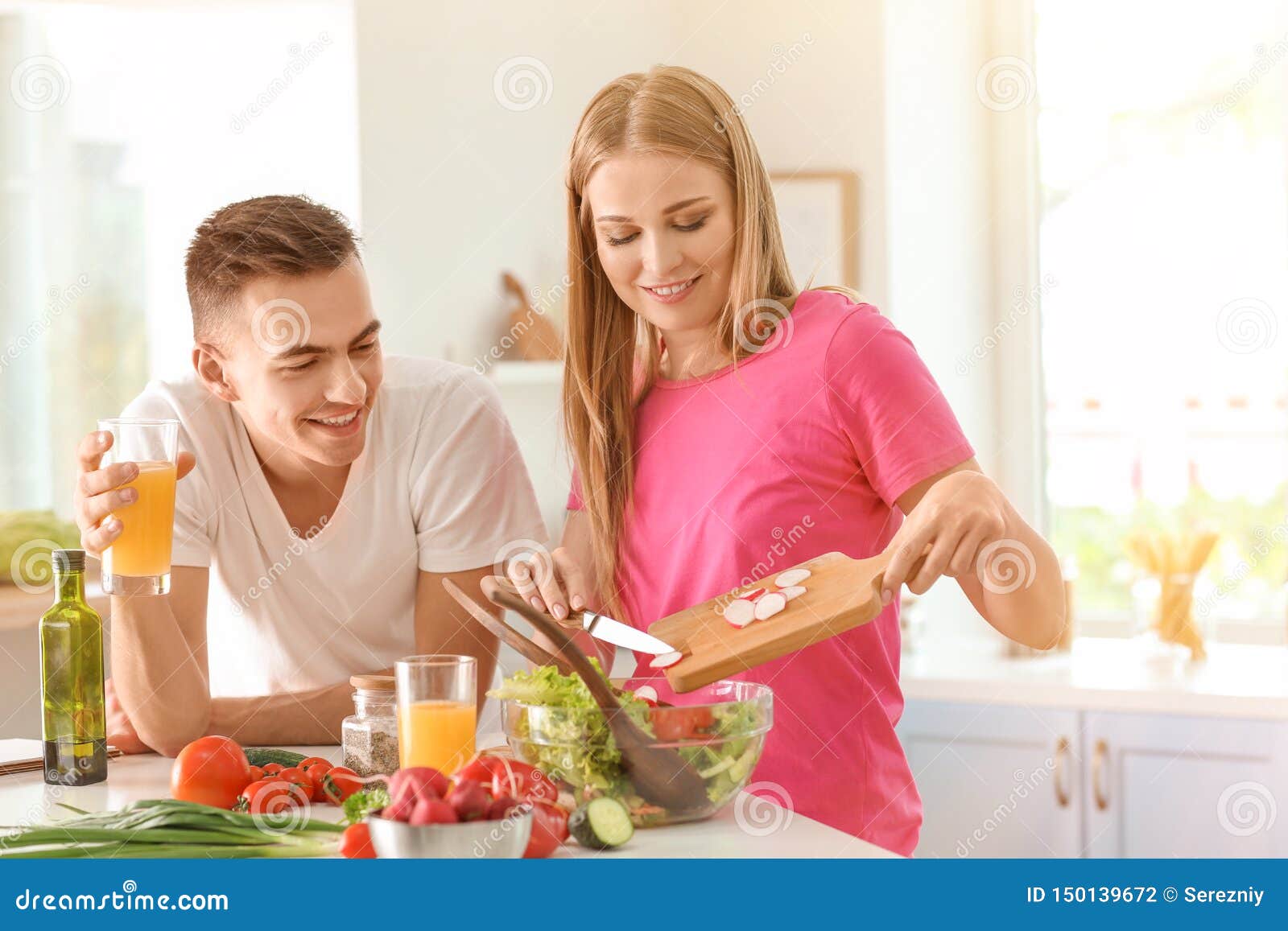 Young Woman Cooking with Her Friend in Kitchen Stock Photo - Image of ...
