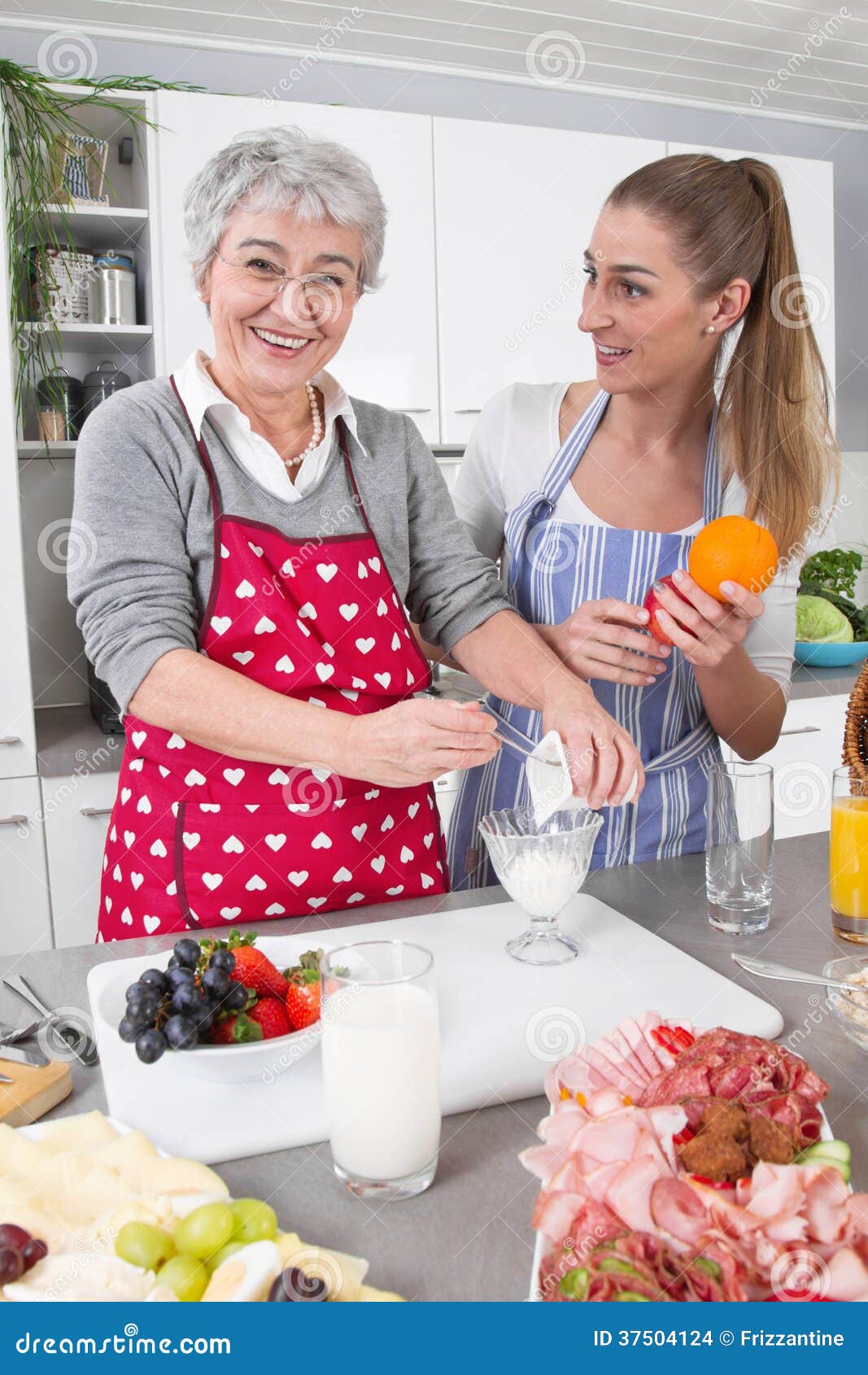 Young Woman Cooking with Her Mother in the Kitchen. Stock Photo - Image ...