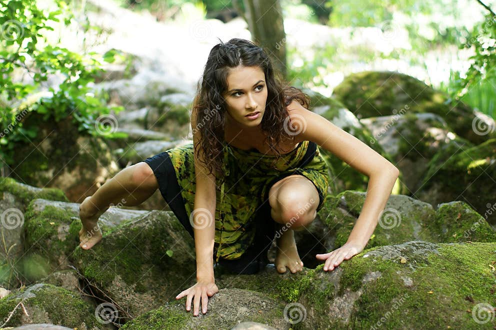 A Young Woman is Crawling in a Deep Forest Stock Photo - Image of ...