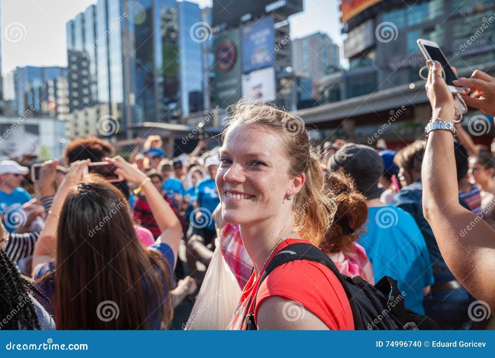 Young woman in the crowd stock photo. Image of hand, music - 74996740