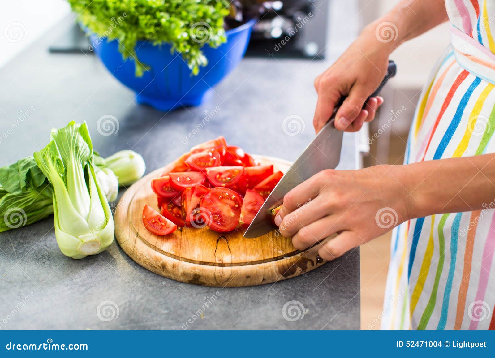 Young Woman Cutting Vegetables in Her Modern Kitchen Stock Photo ...