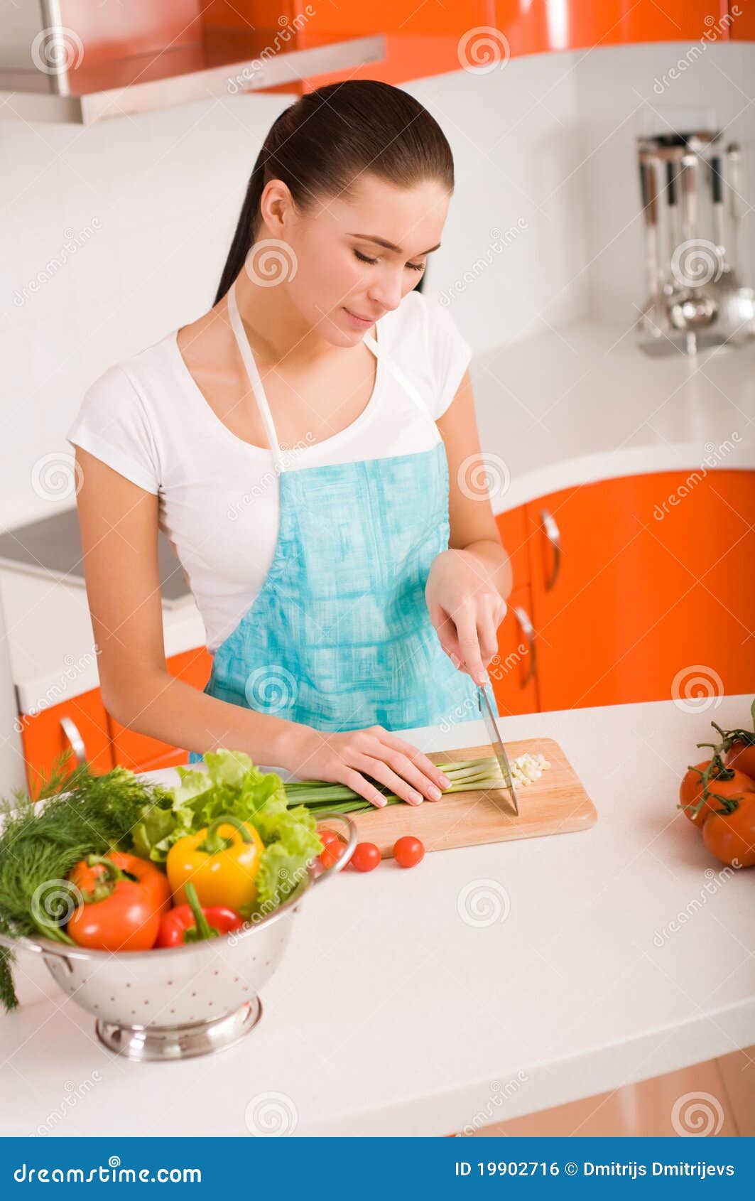 Young Woman Cutting Vegetables in a Kitchen Stock Photo - Image of ...