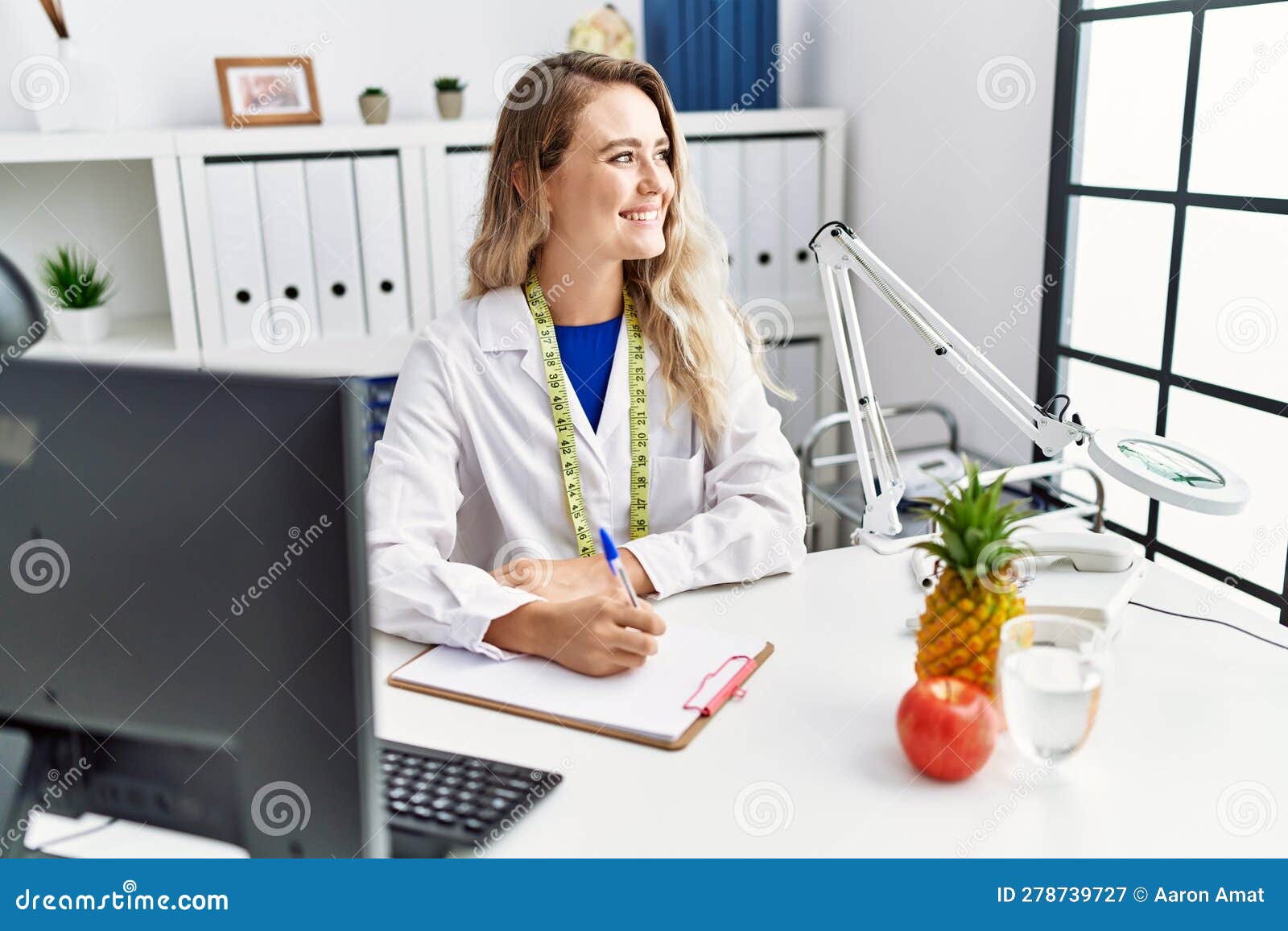 Young Woman Dietician Writing on Document at Clinic Stock Image - Image ...