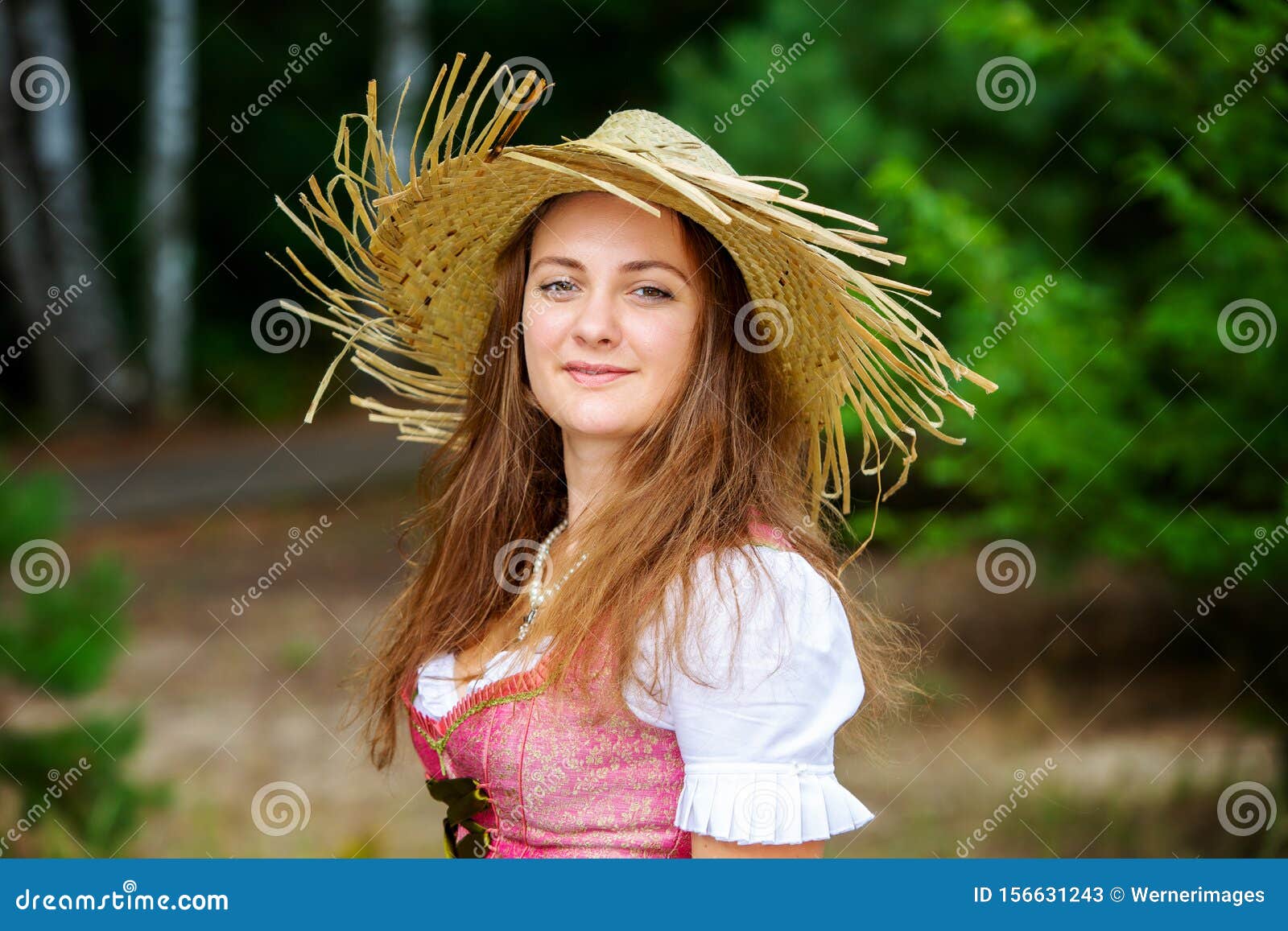Young Woman in Dirndl and Straw Hat Standing Outdoors Stock Image ...