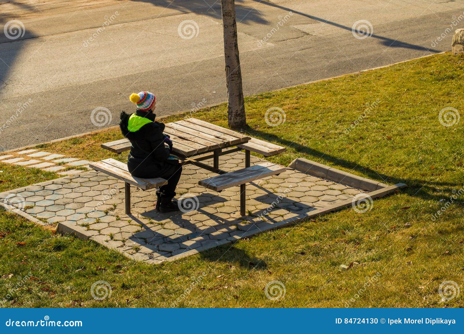 Young Woman in the Distance Sitting Alone on a Bench Stock Photo ...