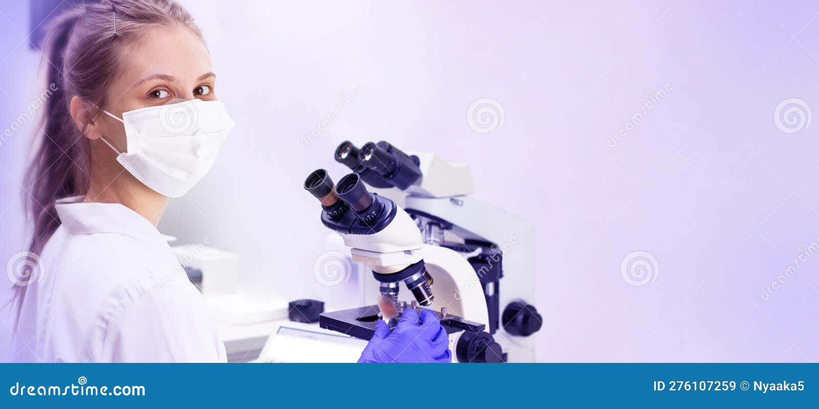 A Young Woman Doctor (laboratory Assistant) Conducts a Study of a Blood ...