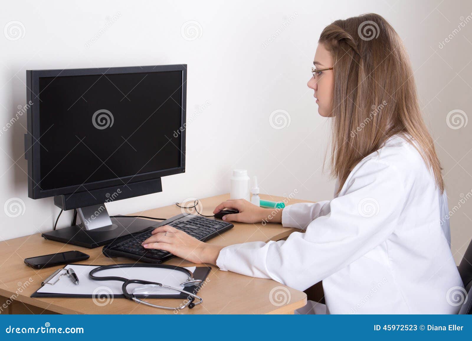 Young Woman Doctor Using Computer with Empty Screen Stock Image - Image ...