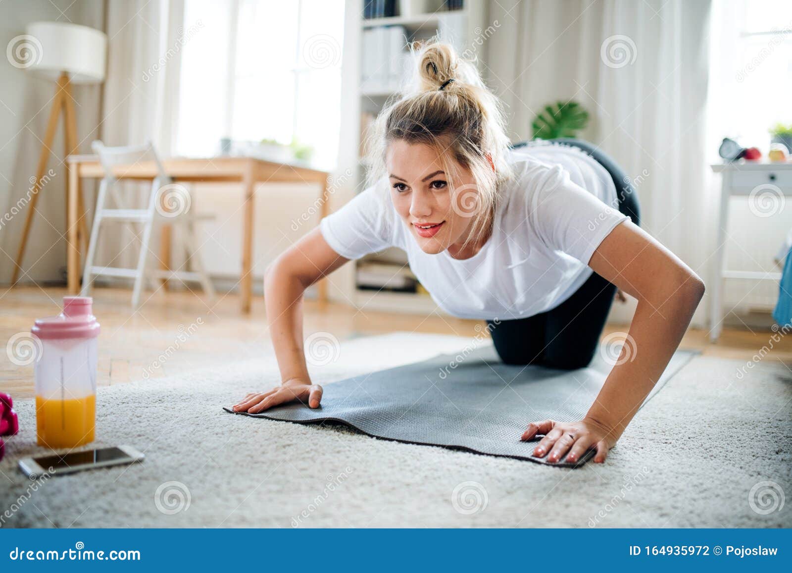 Young Woman Doing Exercise on the Floor Indoors at Home. Stock Photo ...
