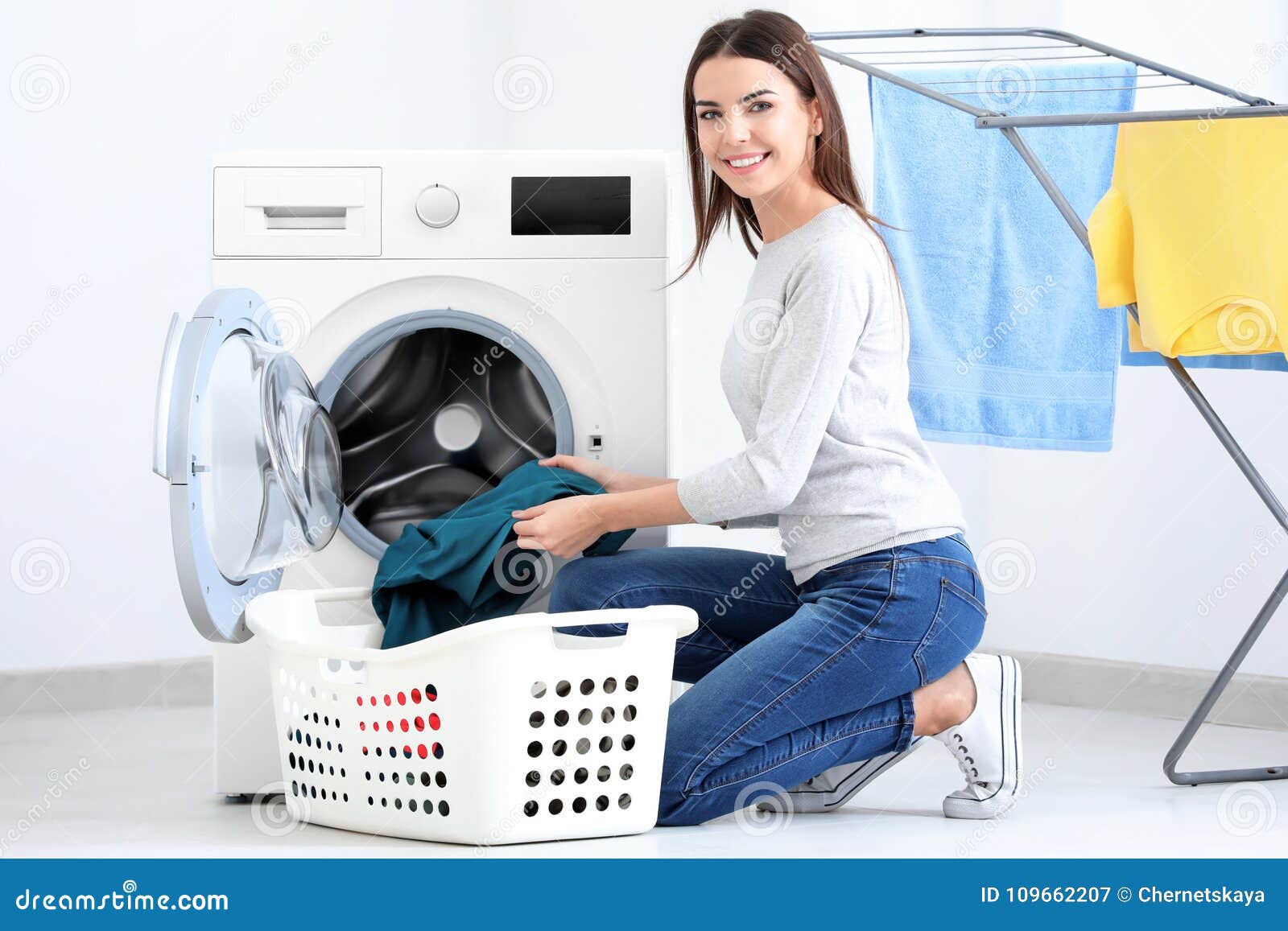 Young woman doing laundry stock image. Image of household - 109662207
