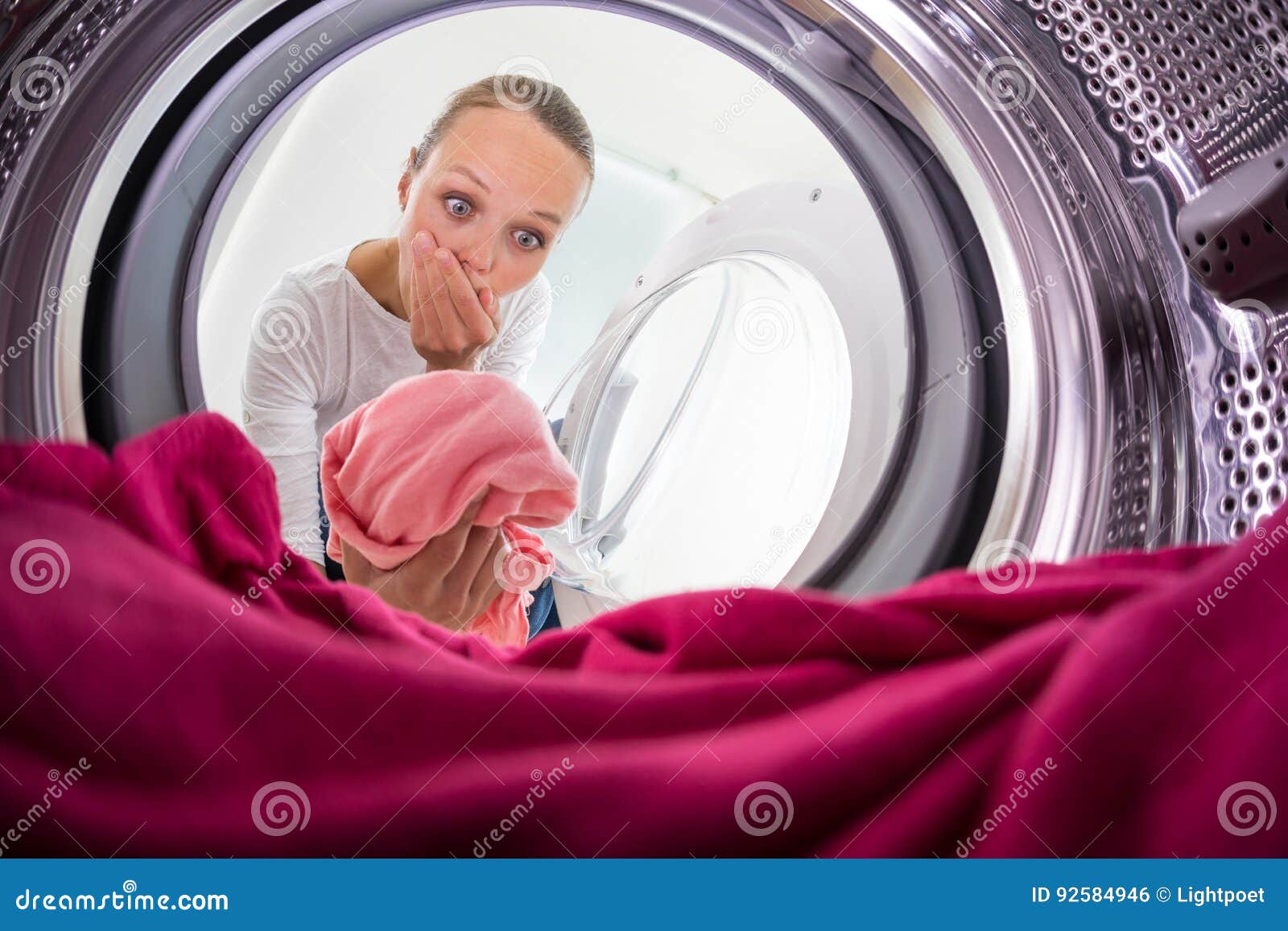 Young woman doing laundry stock photo. Image of indoors - 92584946