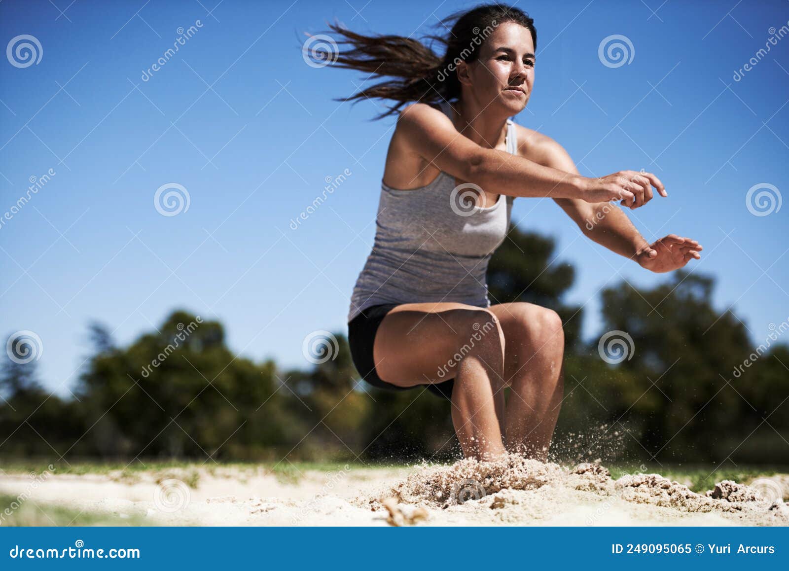 Going As Far As she Can. a Young Woman Doing Long Jump. Stock Image ...