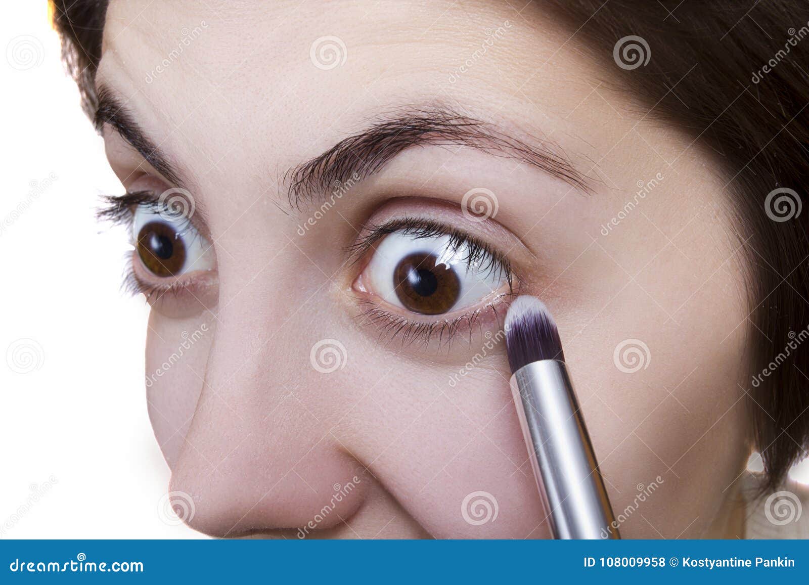 Young woman doing makeup stock photo. Image of woman - 108009958