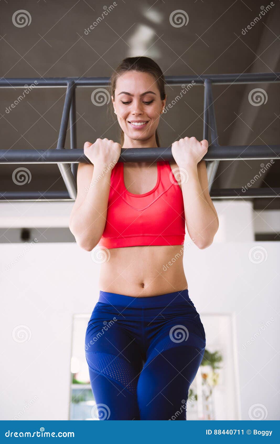 Young woman doing pull-ups stock image. Image of health - 88440711
