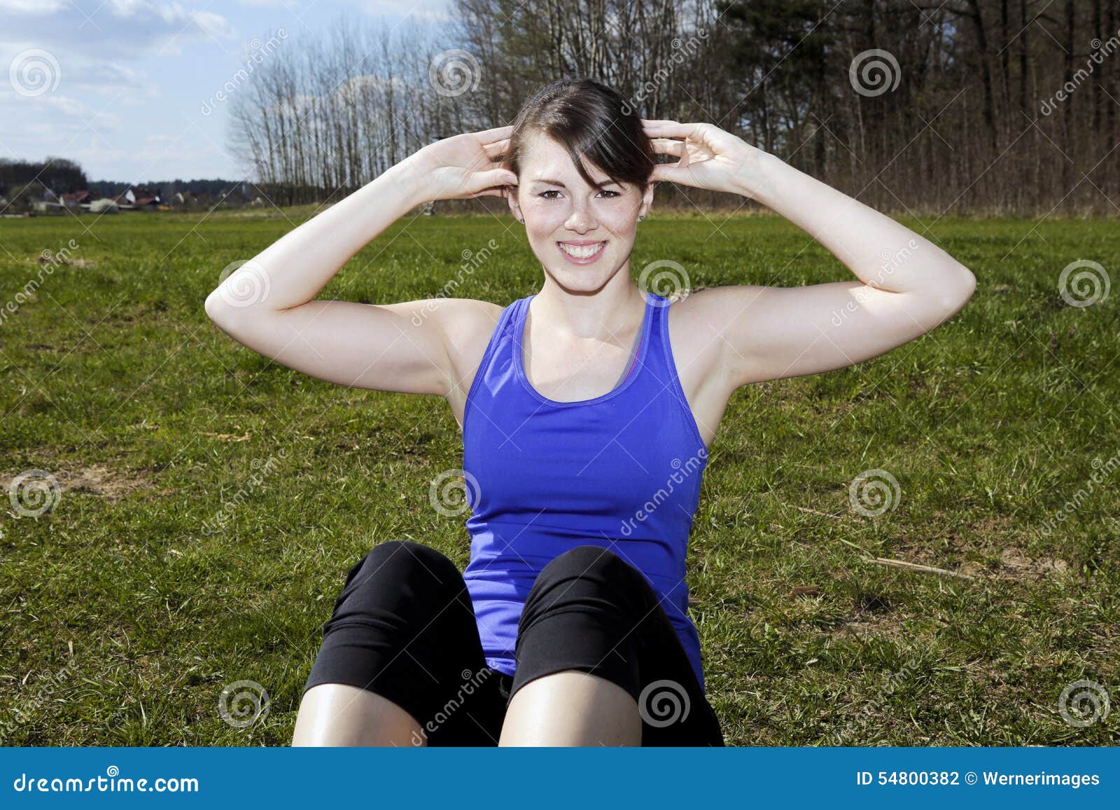 Young Woman Doing Sit-ups Outdoors Stock Photo - Image of smile ...