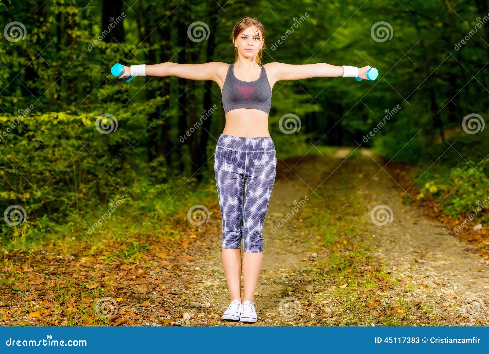 Young Woman Doing Stretching Exercise on Road Forest Stock Image ...