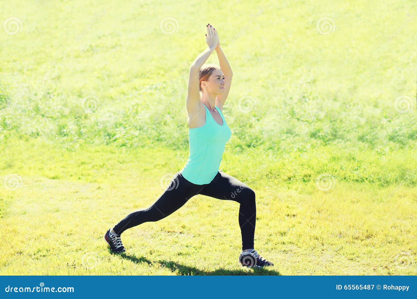 Young Woman Doing Stretching Exercises on Grass in Summer Stock Image ...