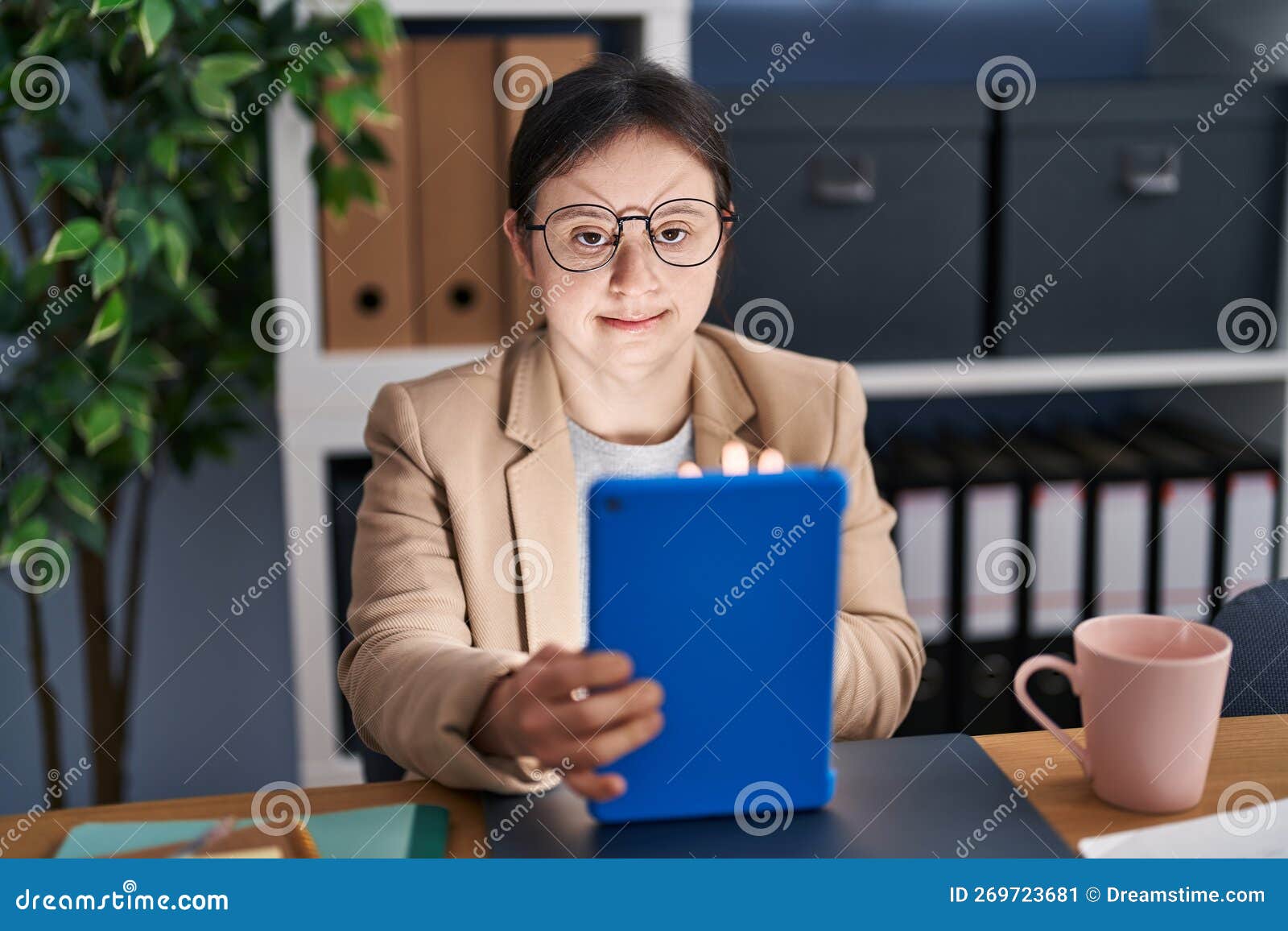 Young Woman with Down Syndrome Business Worker Using Touchpad Working ...