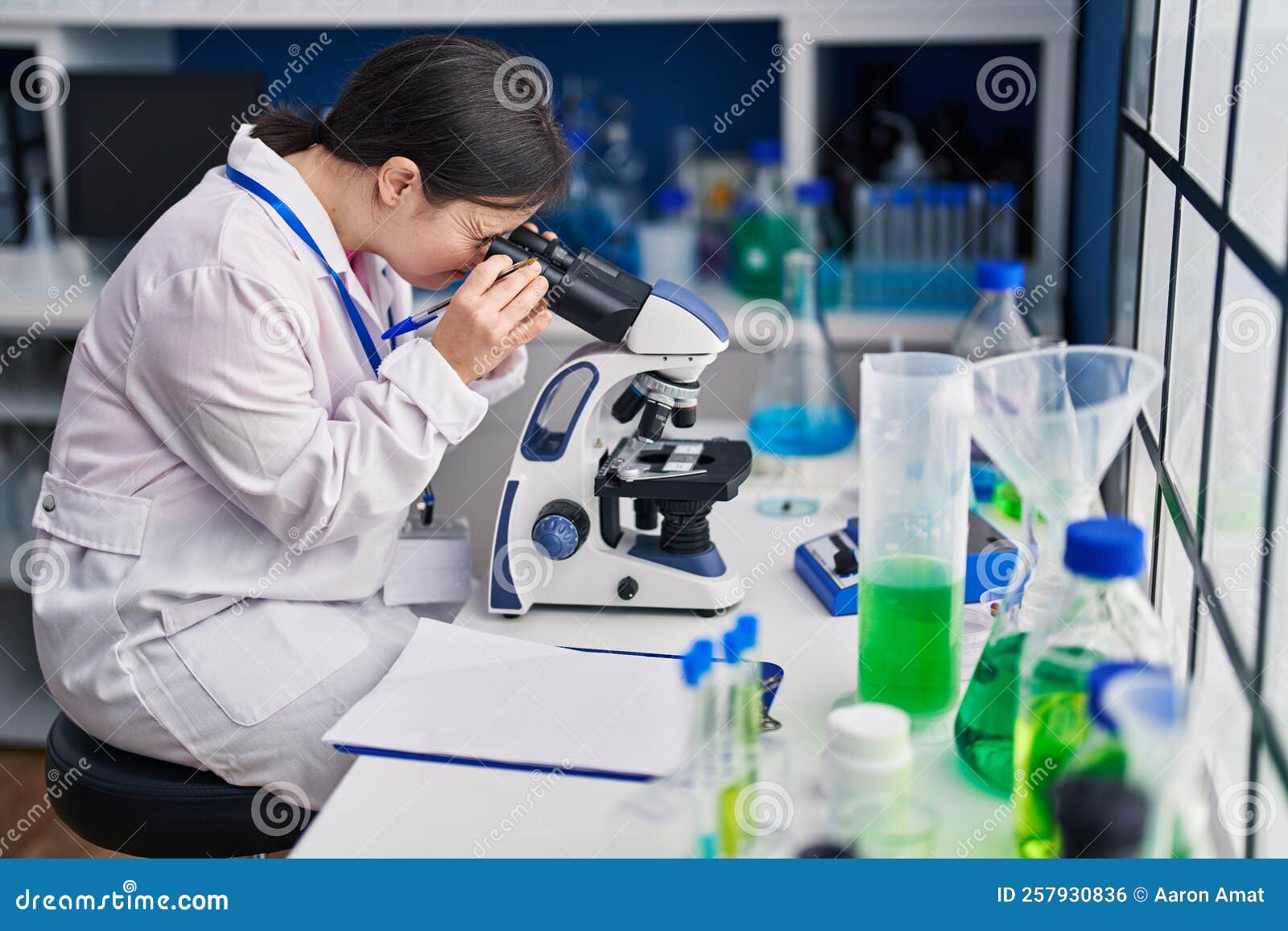 Young Woman with Down Syndrome Scientist Using Microscope at Laboratory ...