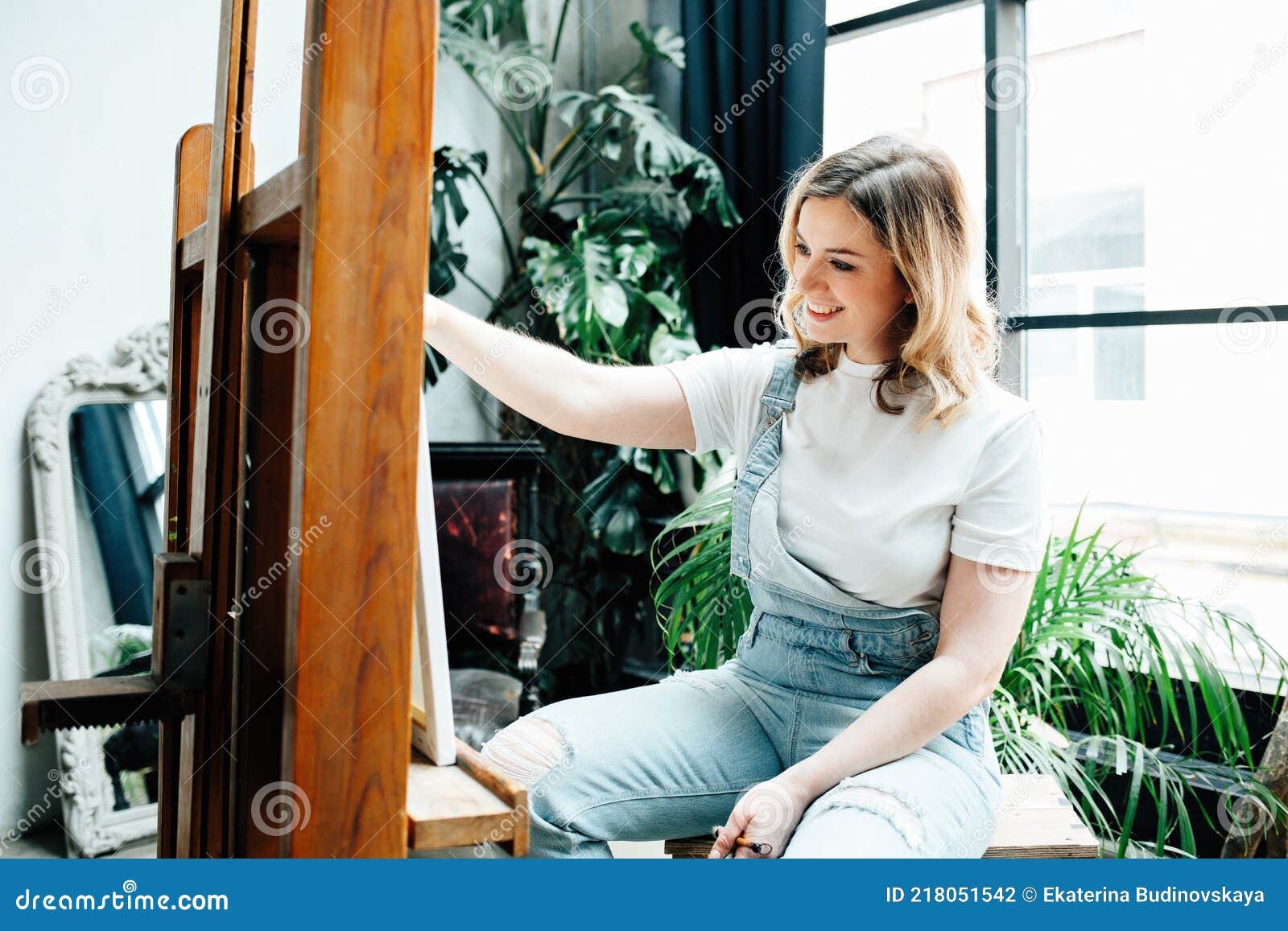 Young Woman Draws in a Light Studio Stock Photo - Image of creative ...