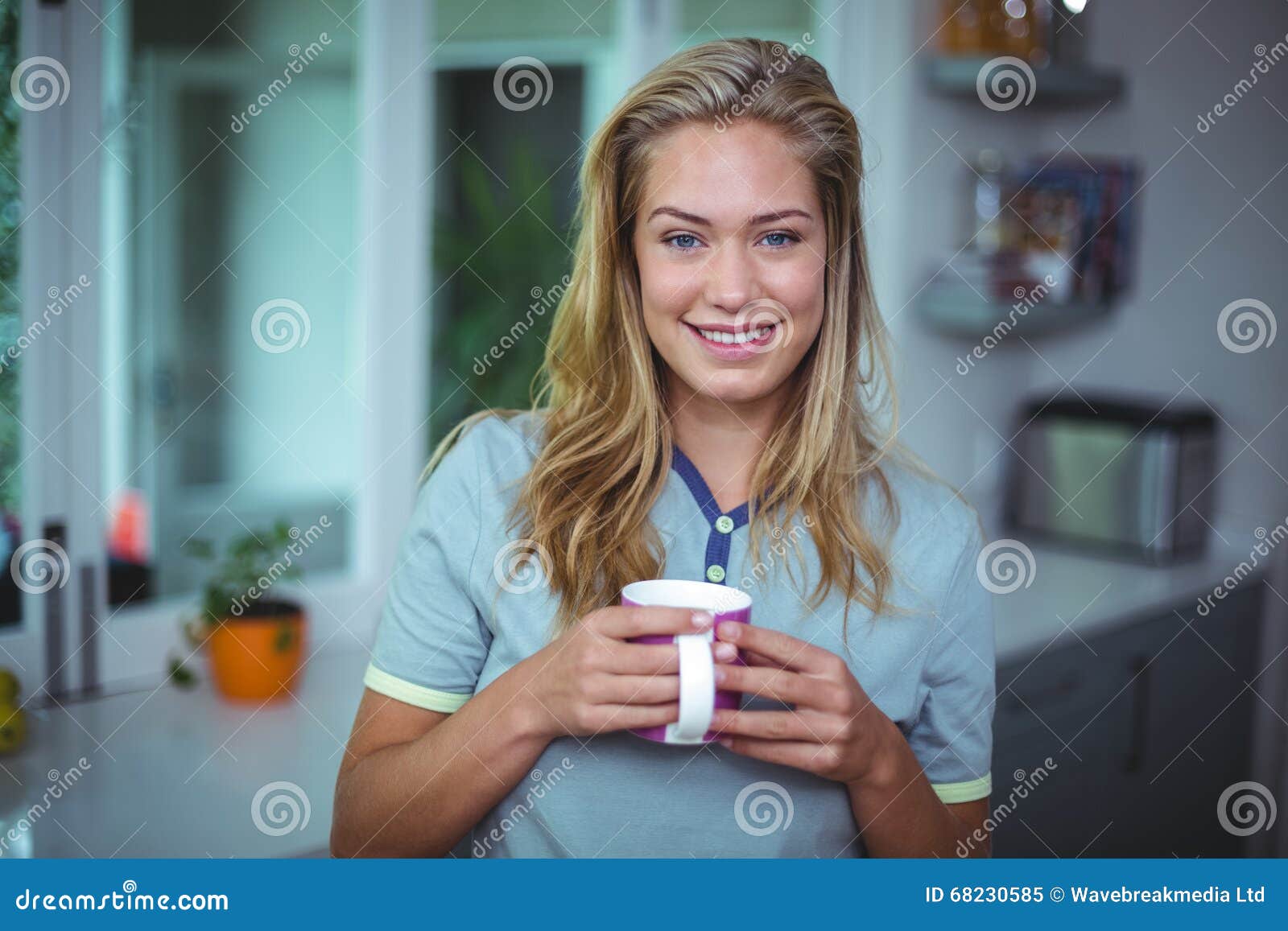 Young Woman Drinking Coffee while Standing in Kitchen Stock Image ...