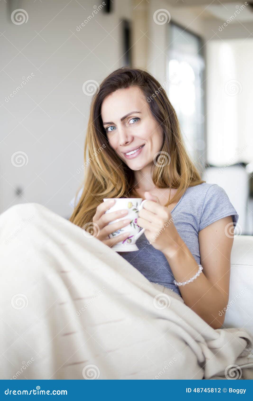 Young woman drinking tea stock photo. Image of indoors - 48745812