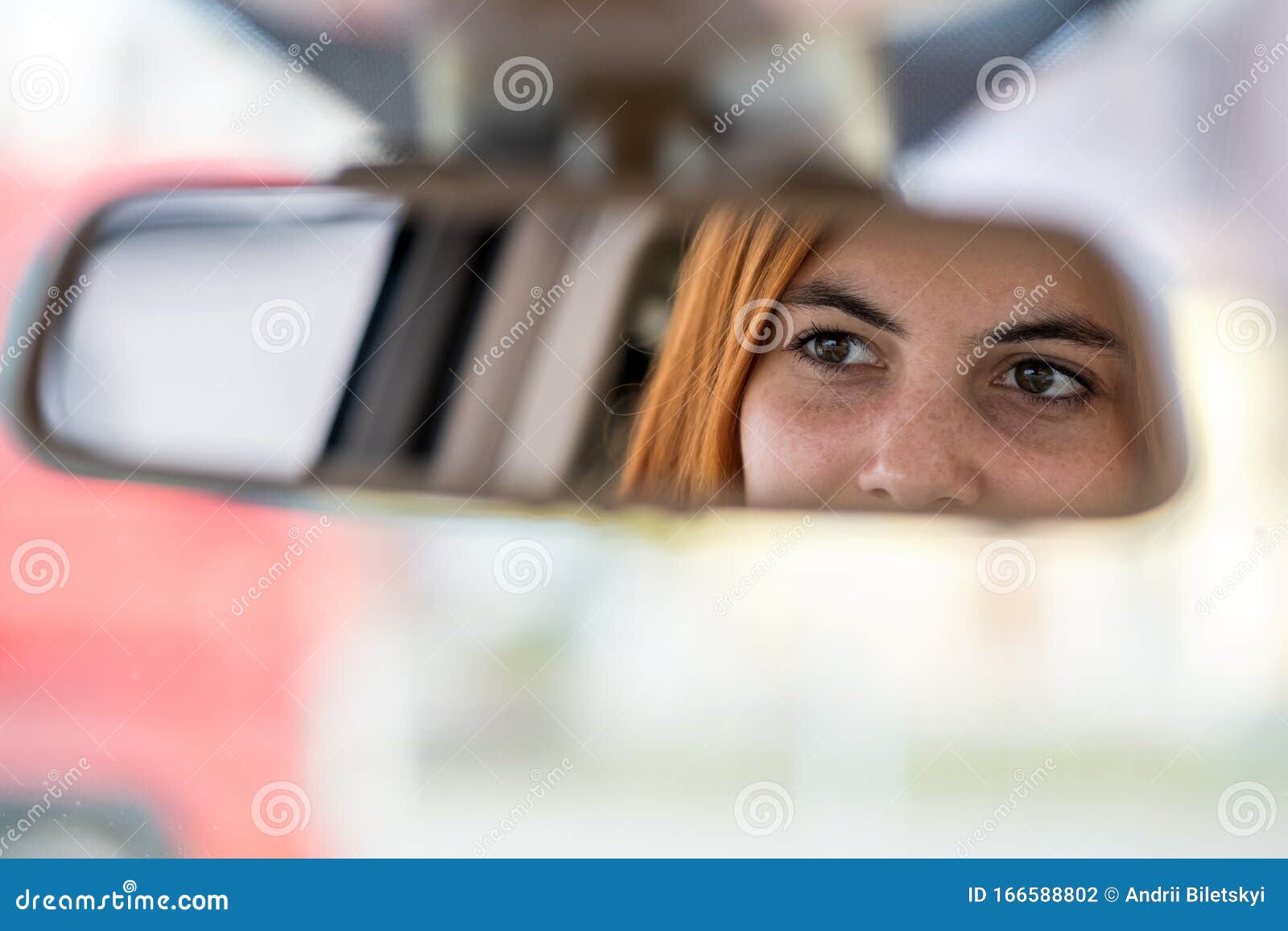 Young Woman Driver Checking Rear View Mirror Looking Backwards while ...