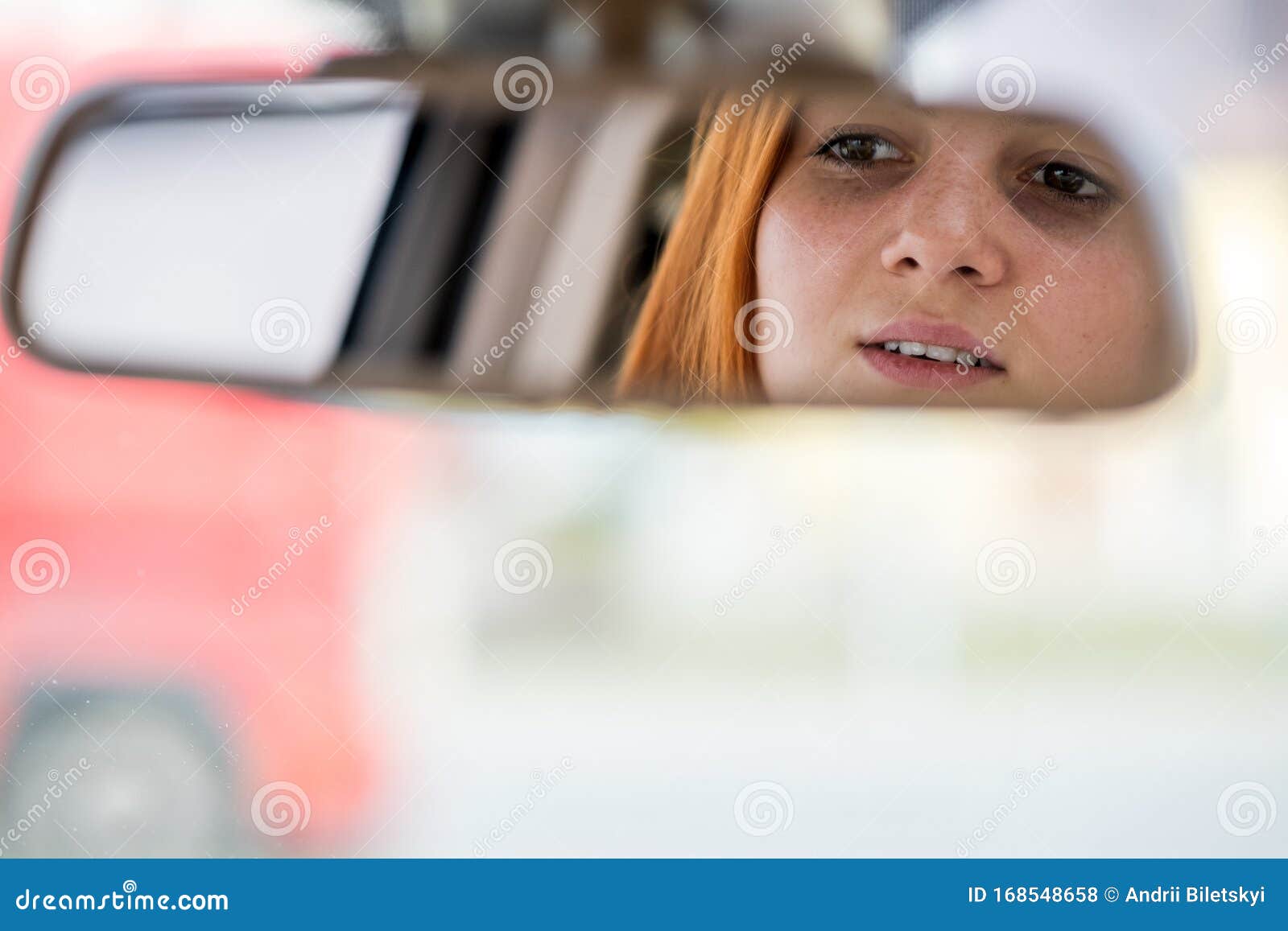 Young Woman Driver Checking Rear View Mirror Looking Backwards while ...