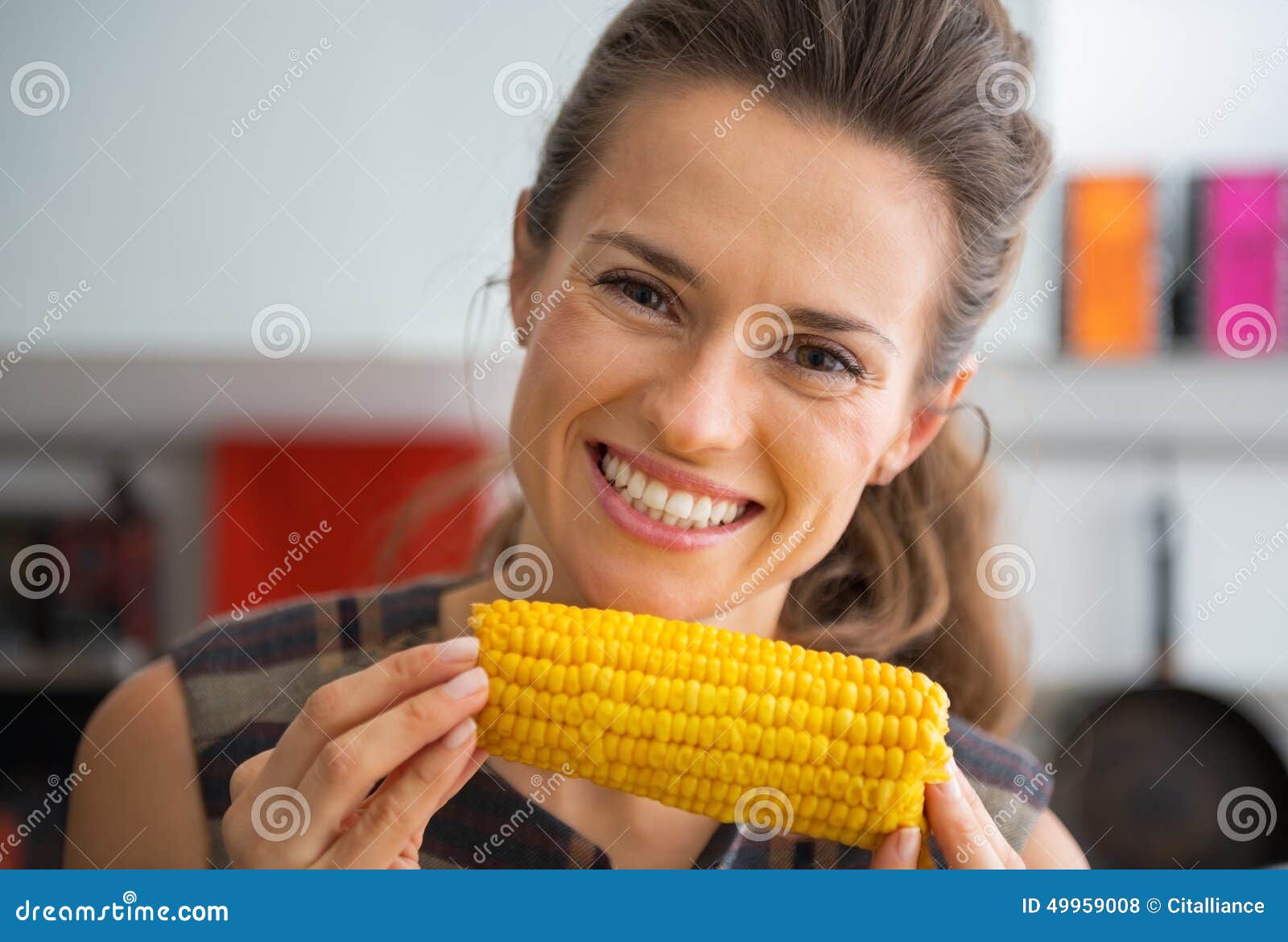 Young Woman Eating Boiled Corn in Kitchen Stock Photo - Image of maize ...