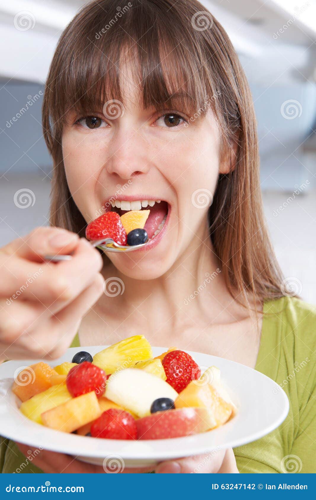 Young Woman Eating Bowl of Fresh Fruit Salad Stock Photo - Image of ...