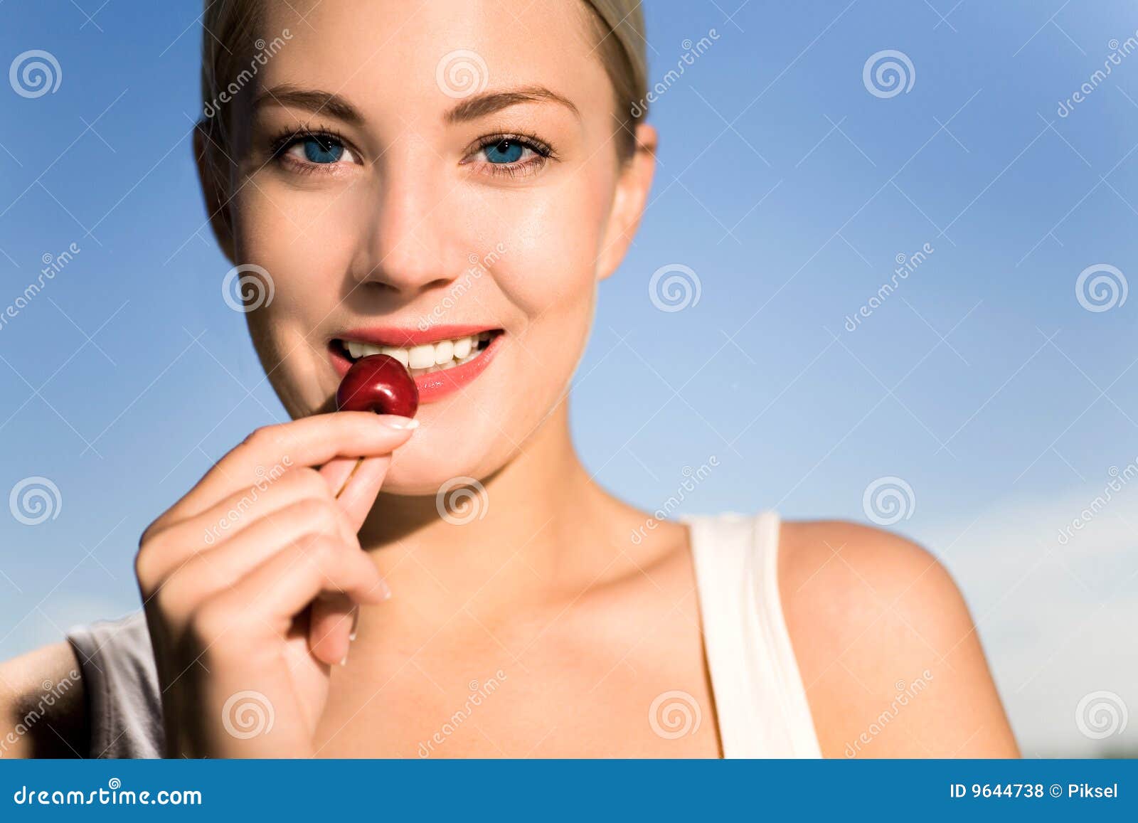 Young woman eating cherry stock photo. Image of fruit - 9644738