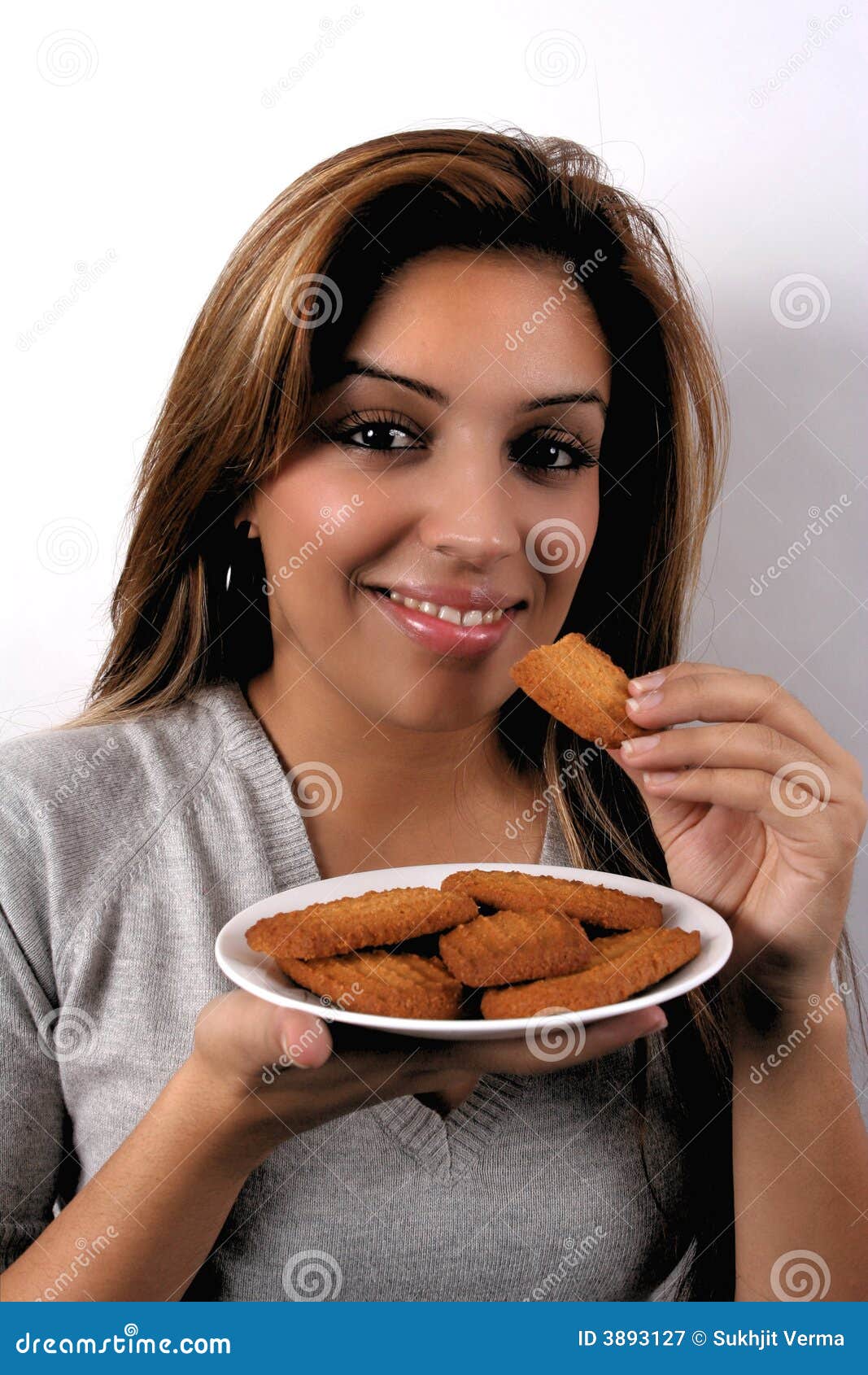 Young woman eating cookies stock image. Image of hold - 3893127