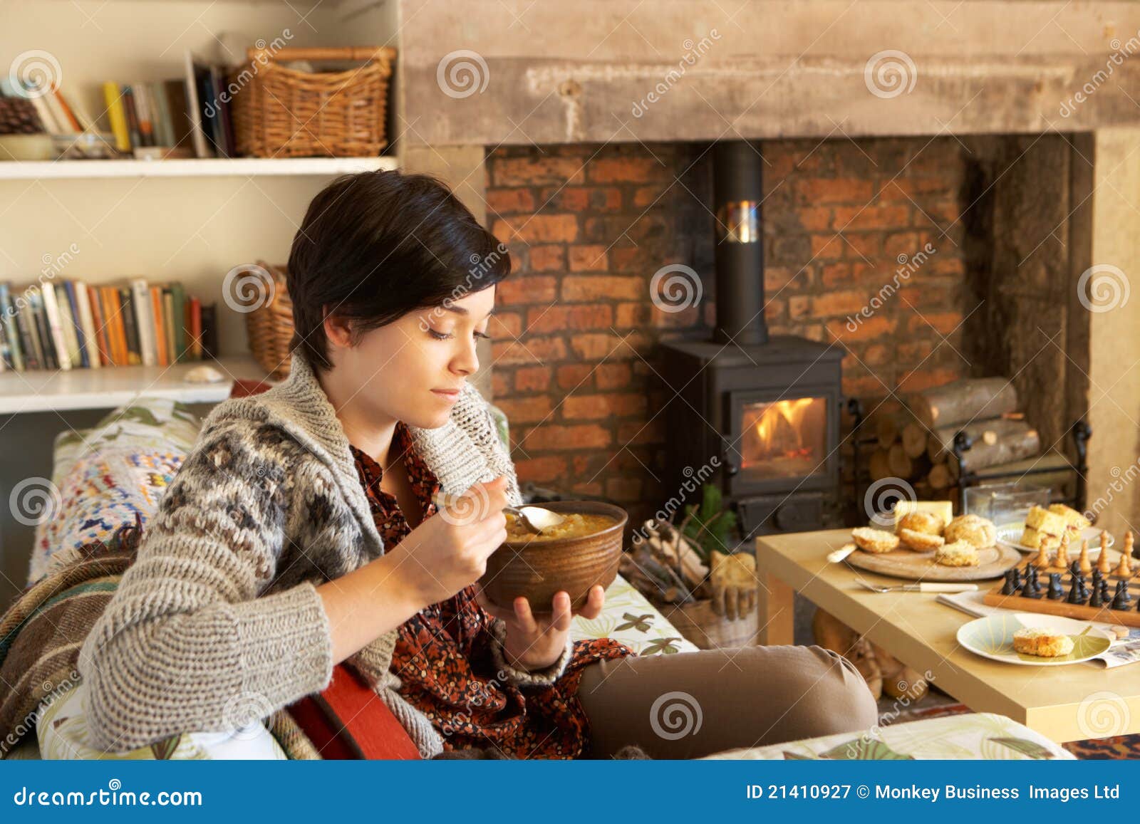 Young Woman Eating Dinner by Fire Stock Image - Image of cottage ...