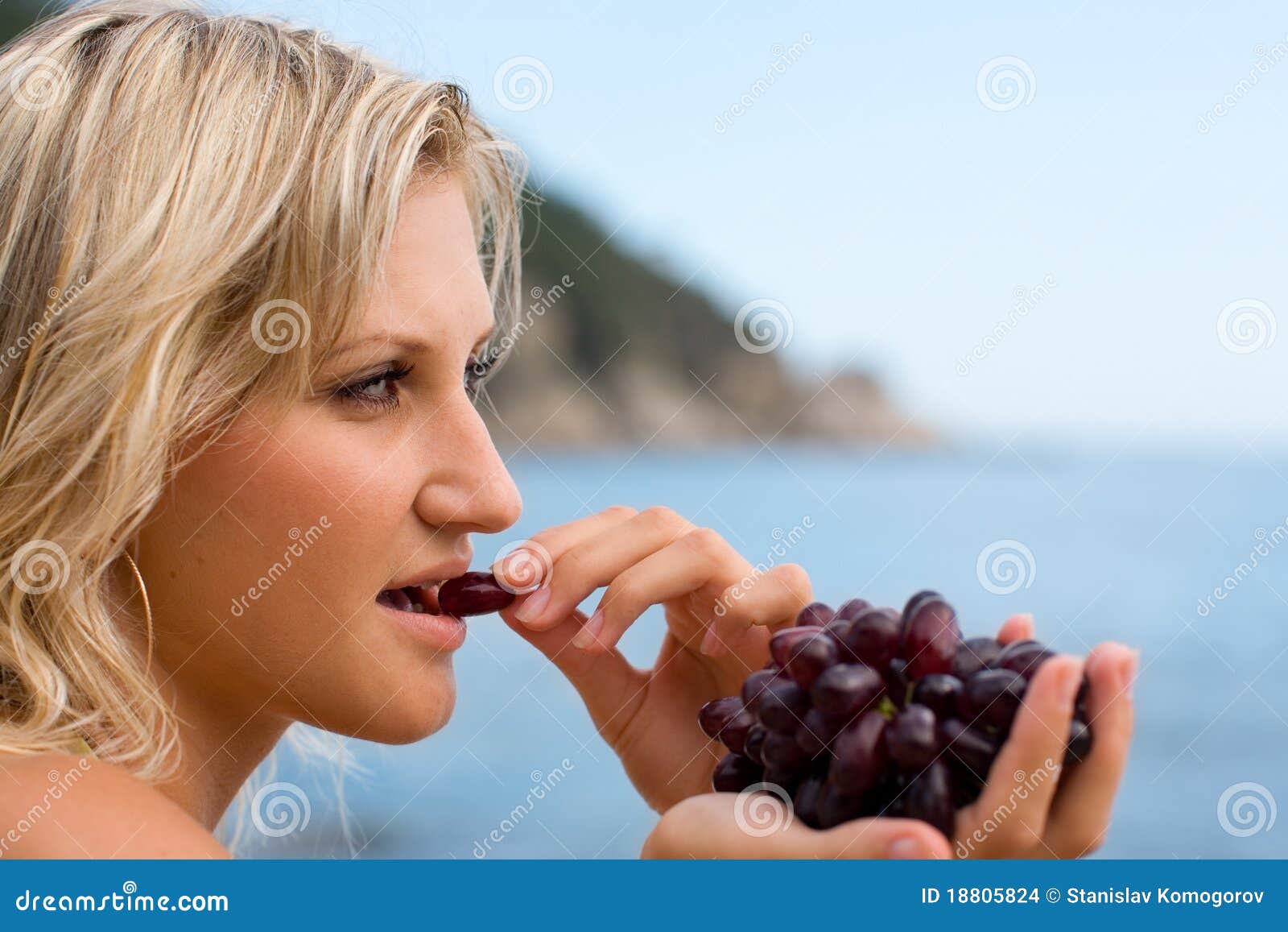 Young woman eating grapes stock photo. Image of head - 18805824