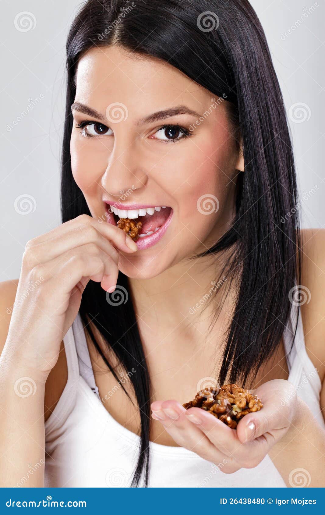 Young woman eating nut stock photo. Image of mouth, face - 26438480