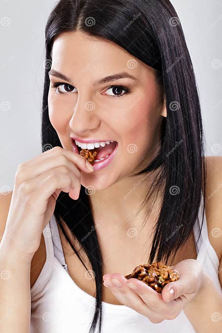 Young woman eating nut stock photo. Image of mouth, face - 26438480