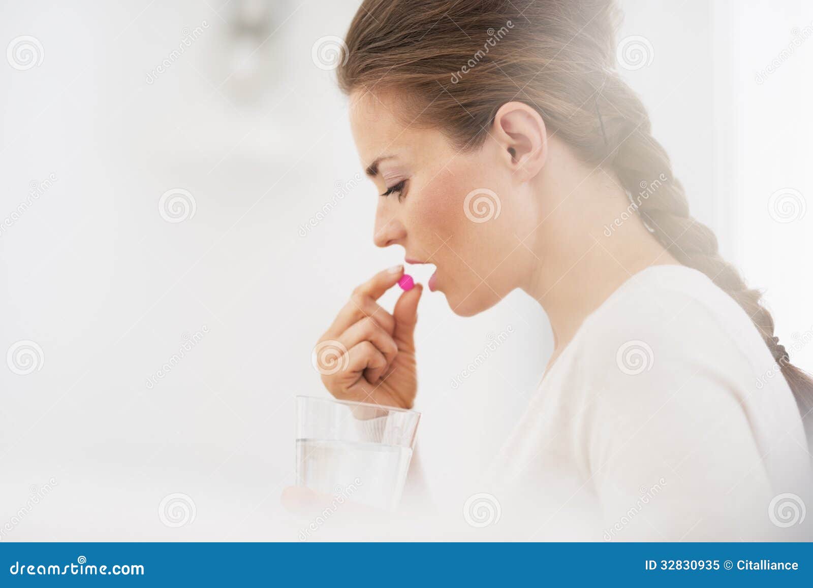 Young woman eating pill stock image. Image of medicinal - 32830935