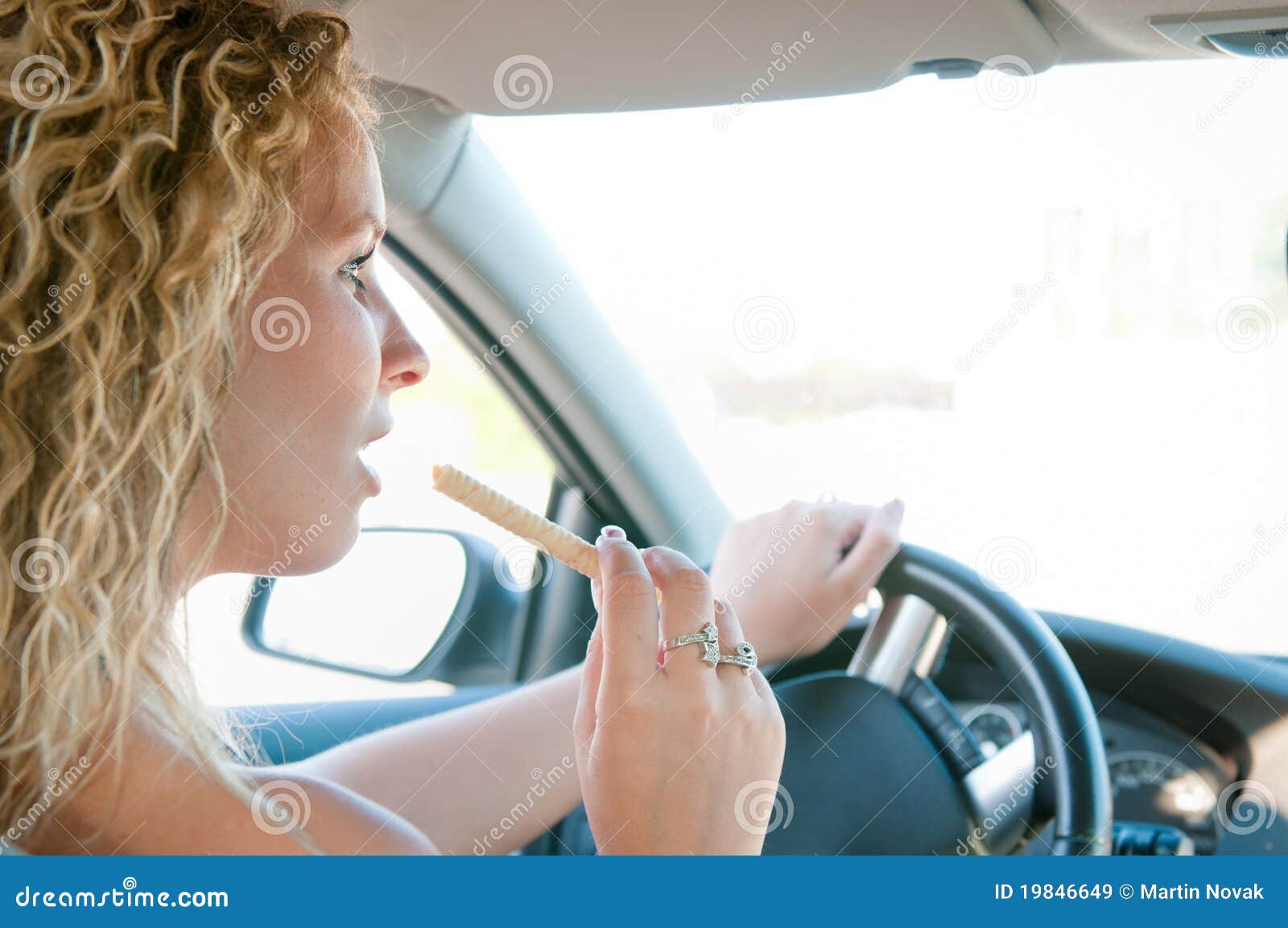 Young Woman Eating Sweets while Driving Car Stock Image - Image of head ...