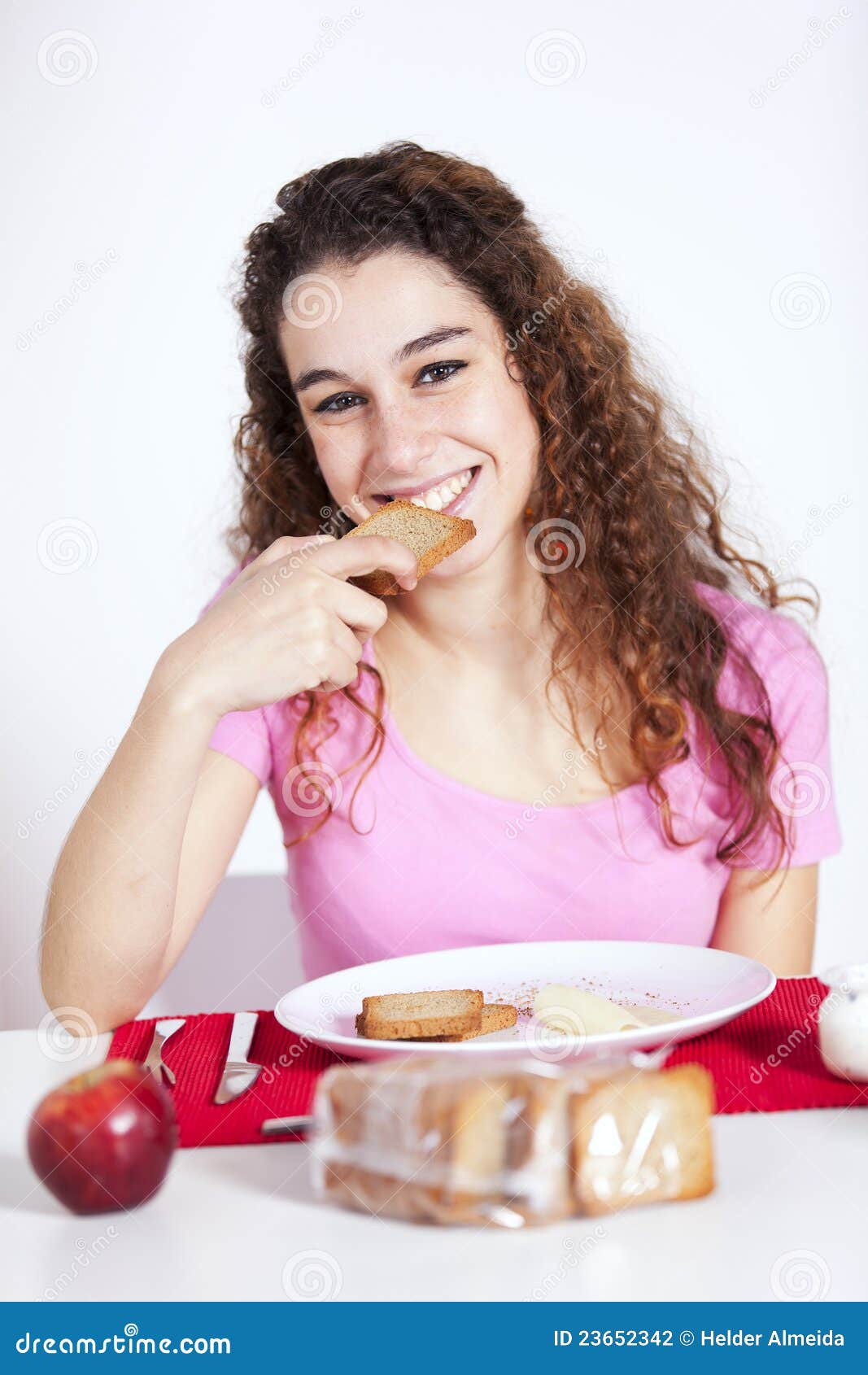 Young woman eating toast stock photo. Image of portrait - 23652342