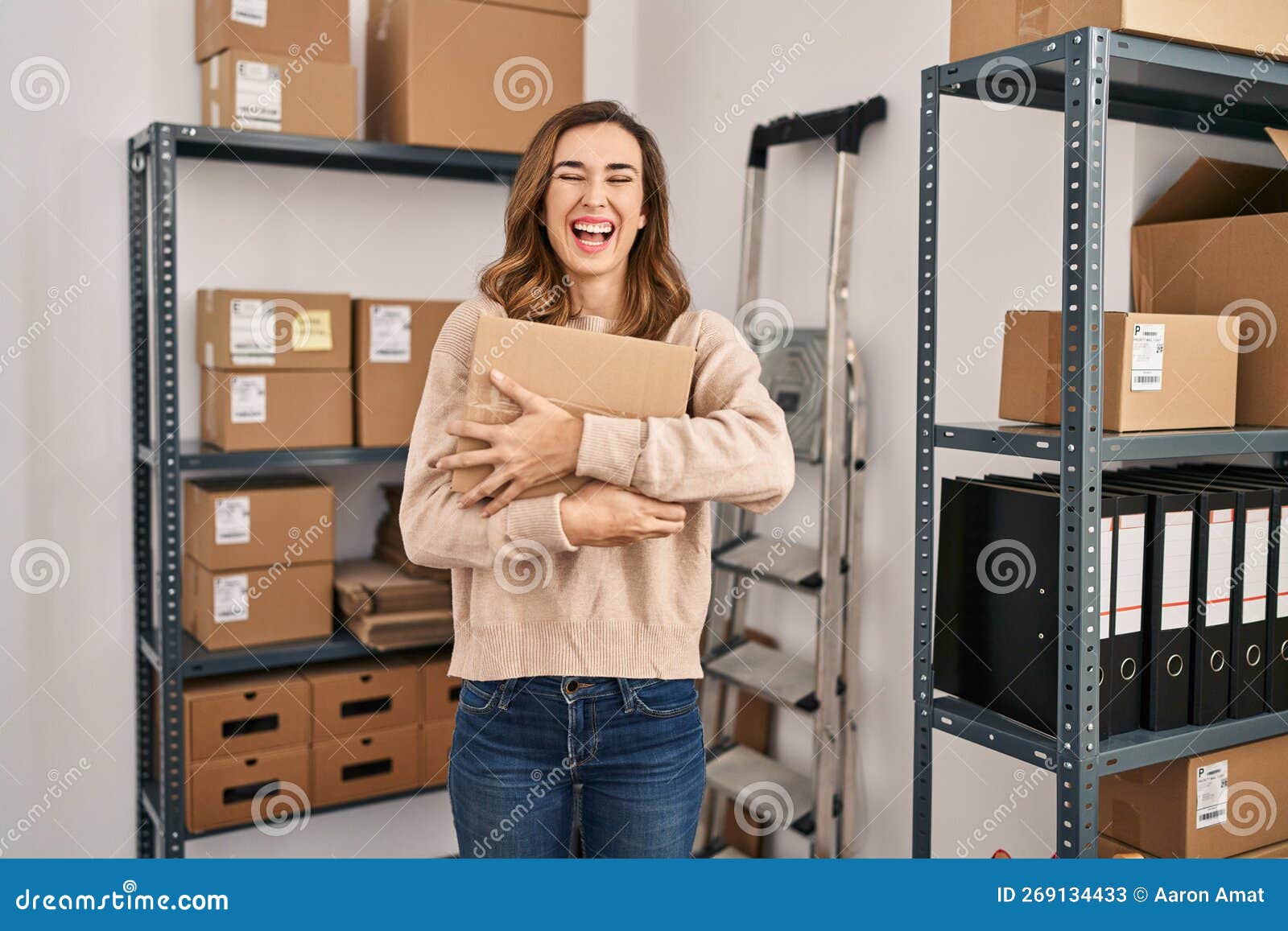 Young Woman Ecommerce Business Worker Hugging Package at Office Stock ...