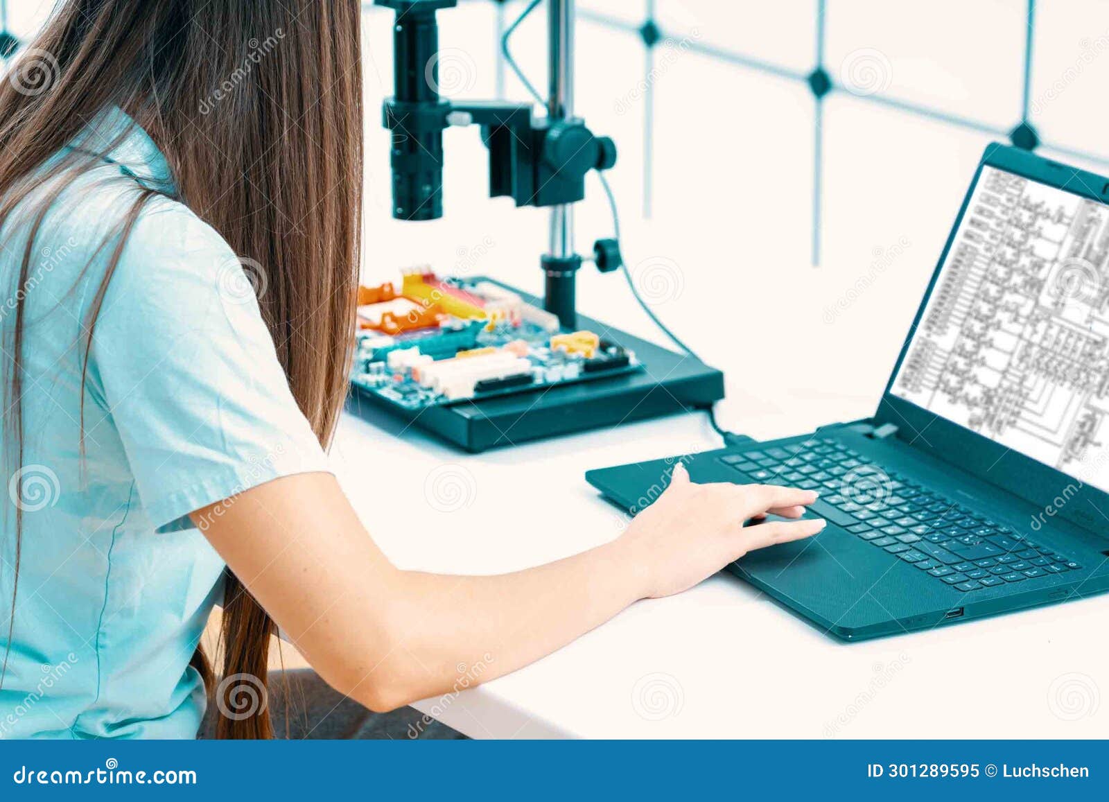 Young Woman in an Electronics Laboratory Testing a Printed Circuit ...